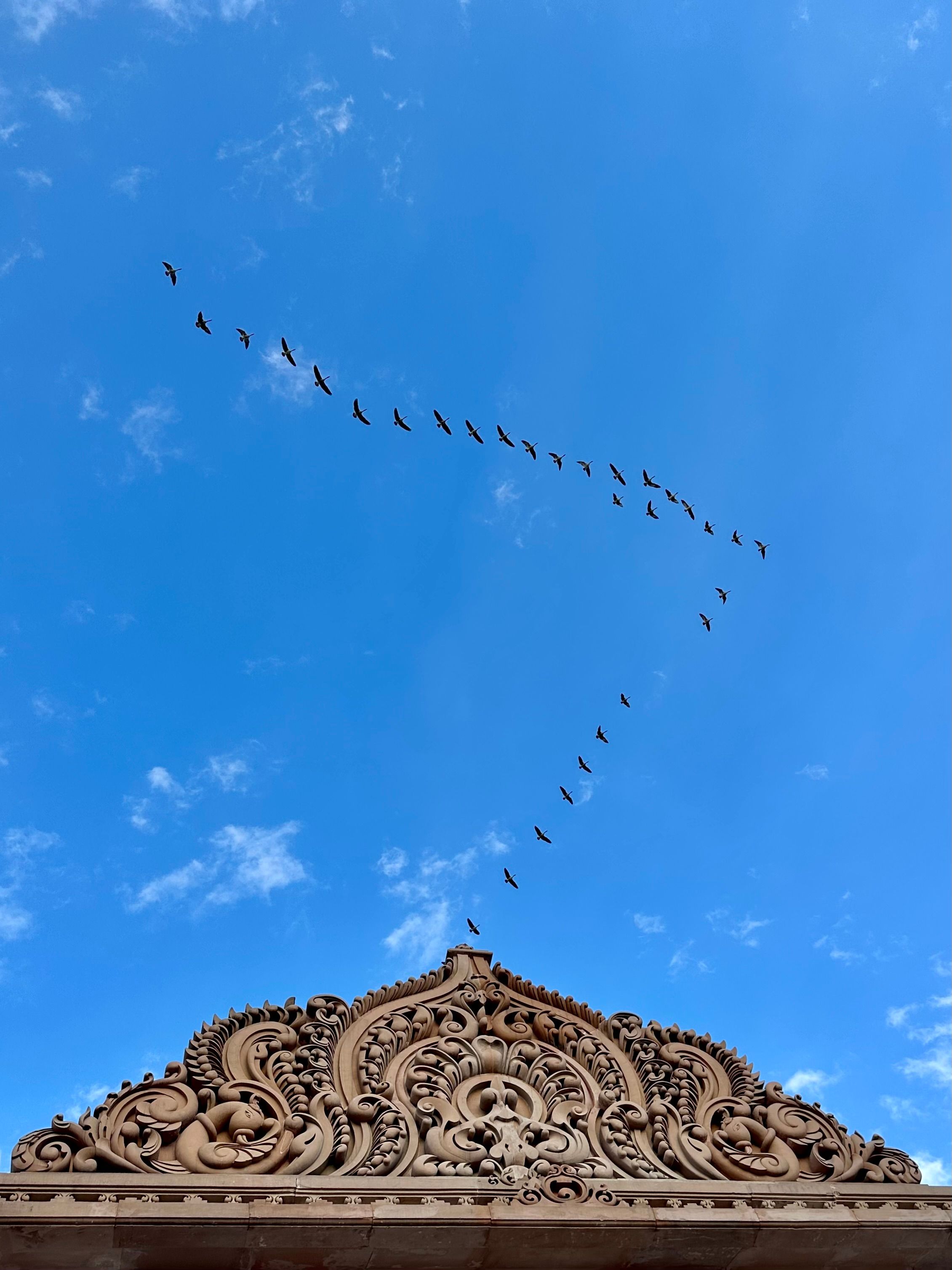 Birds in V Formation Over Decorated Temple · Free Stock Photo
