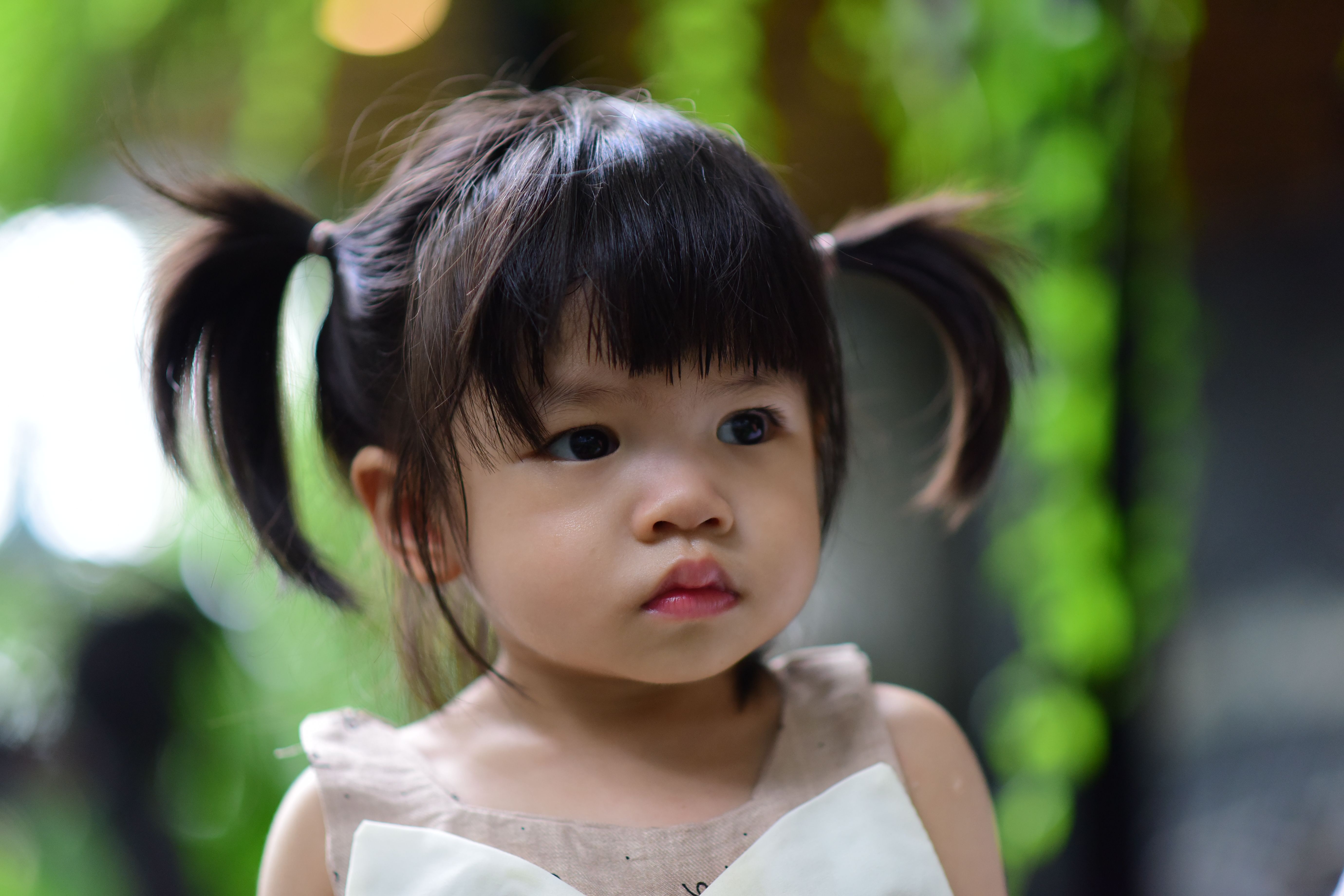 Adorable Child with Pigtails in Outdoor Setting · Free Stock Photo
