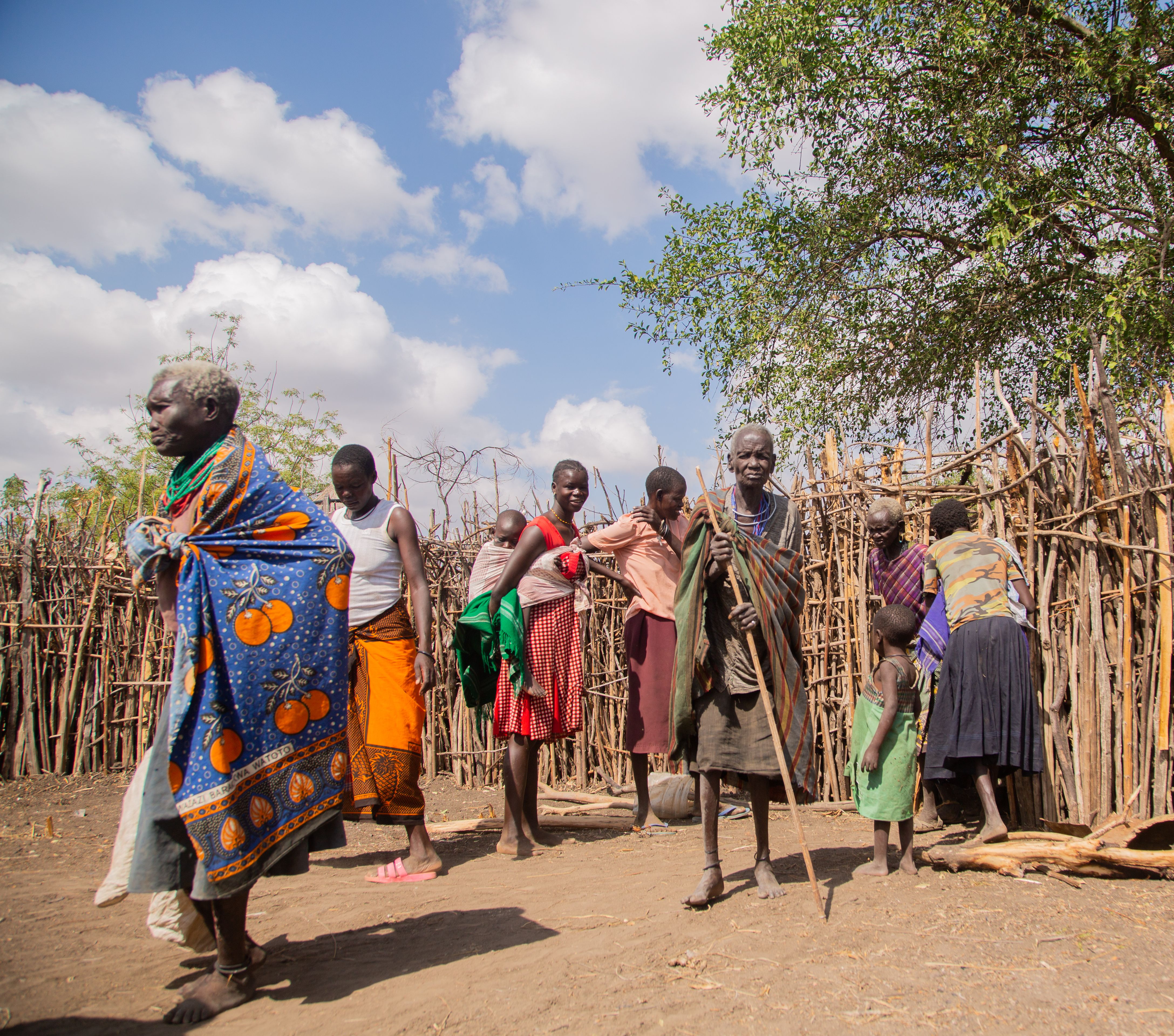A Crowd Sitting Outside in an African Village · Free Stock Photo