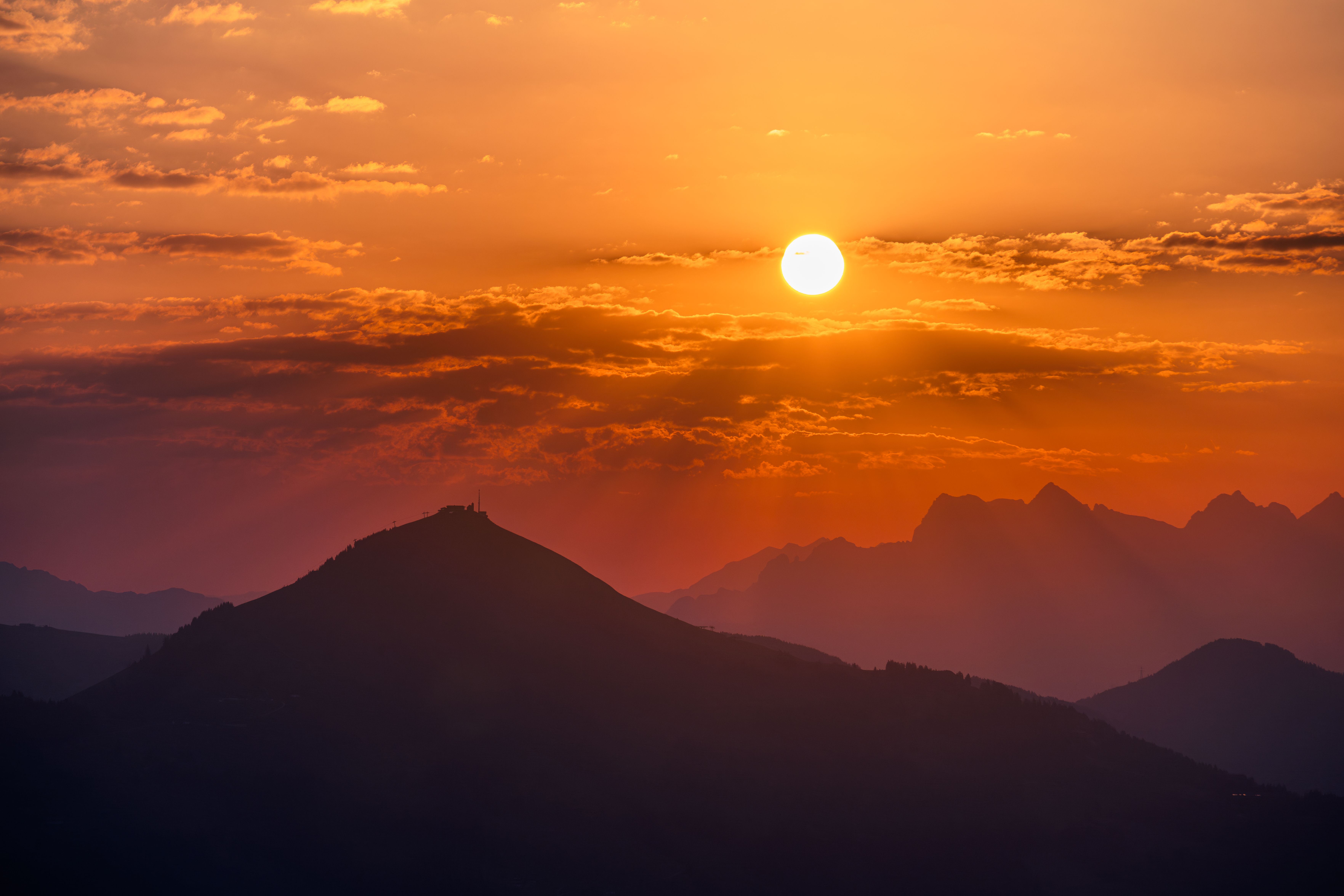 Dramatic Sunset Over Mountainous Landscape · Free Stock Photo