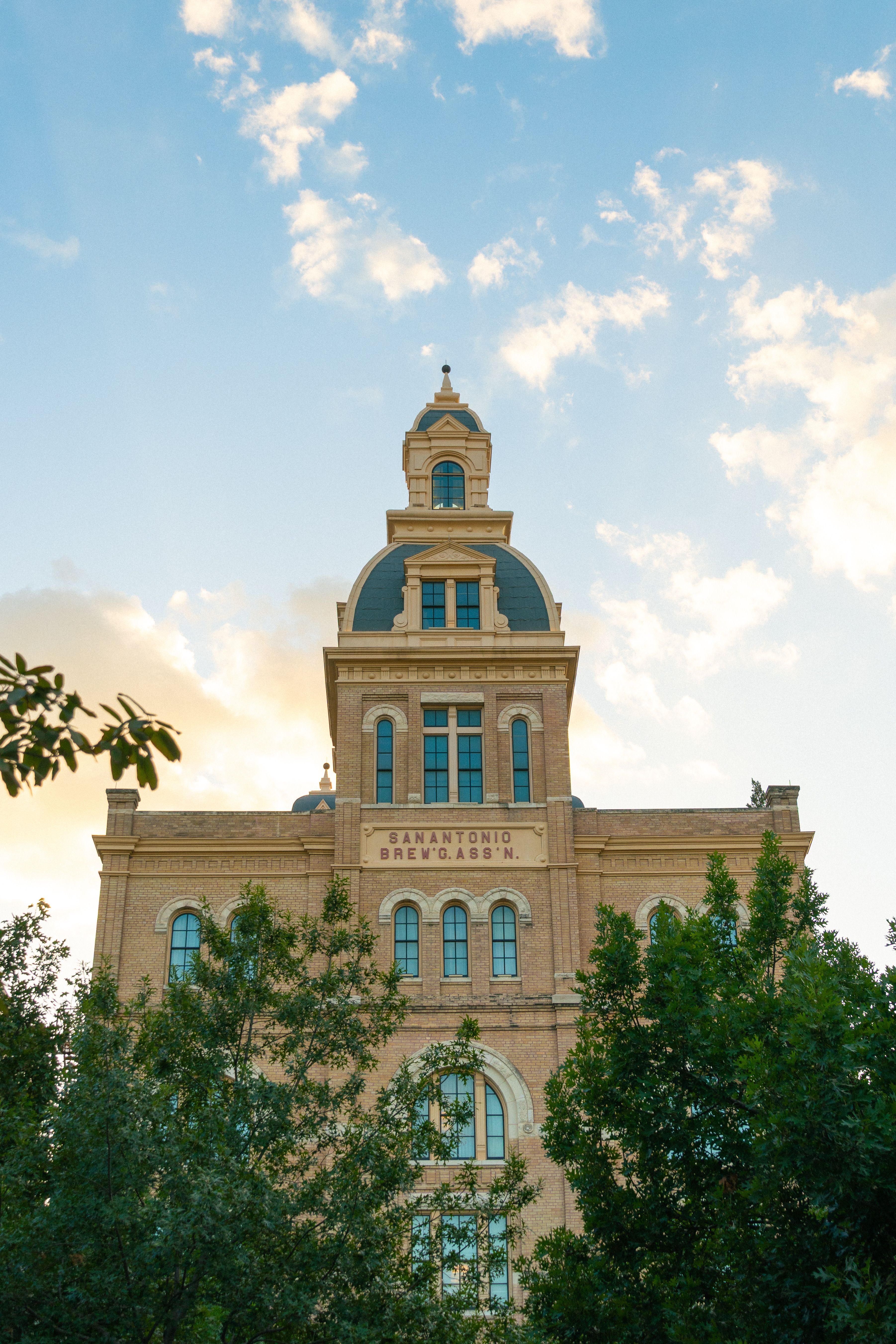 Iconic Brewery Building Against Blue Sky · Free Stock Photo