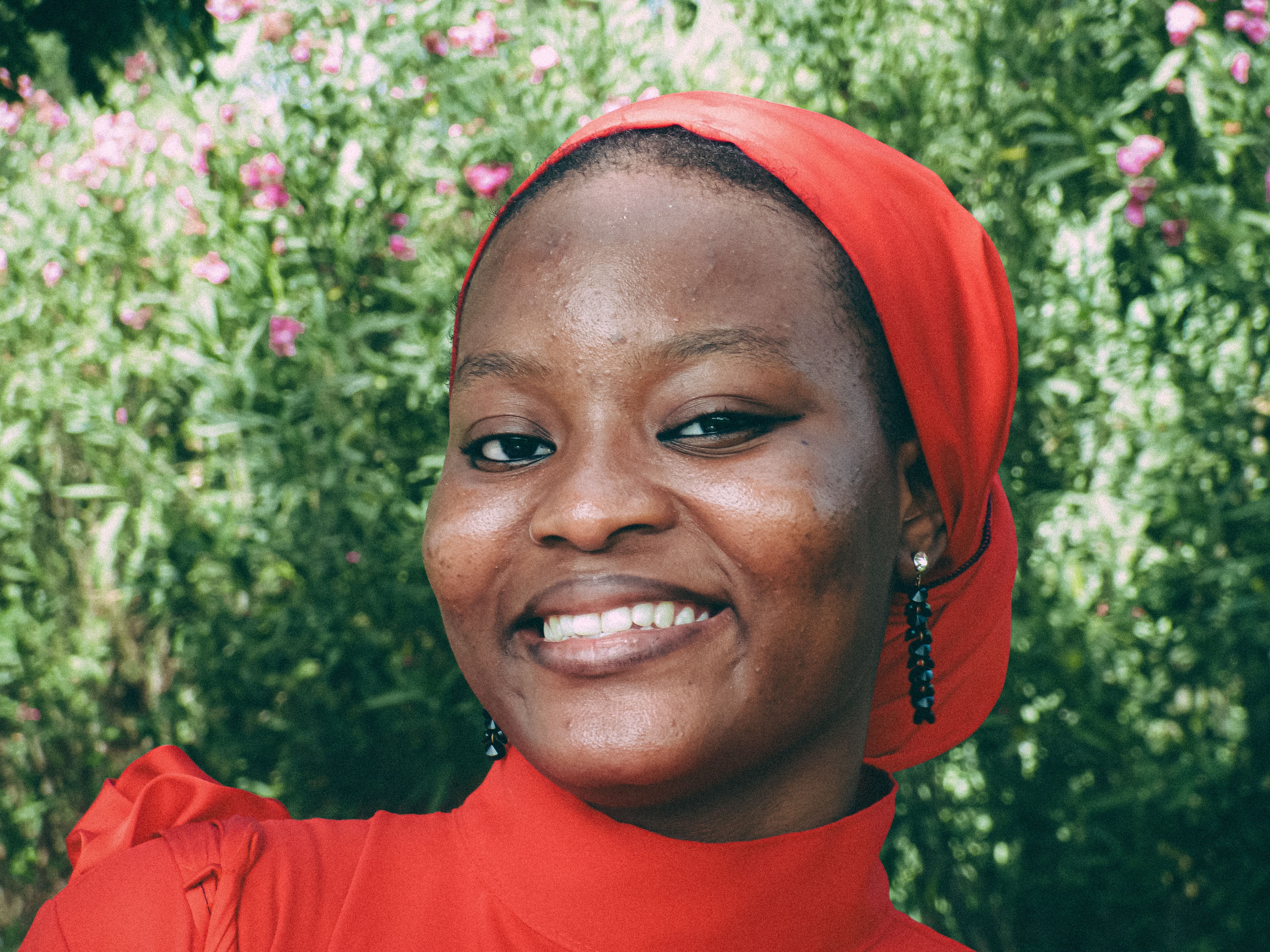 Smiling Woman in Red Headscarf in Tangier Garden · Free Stock Photo