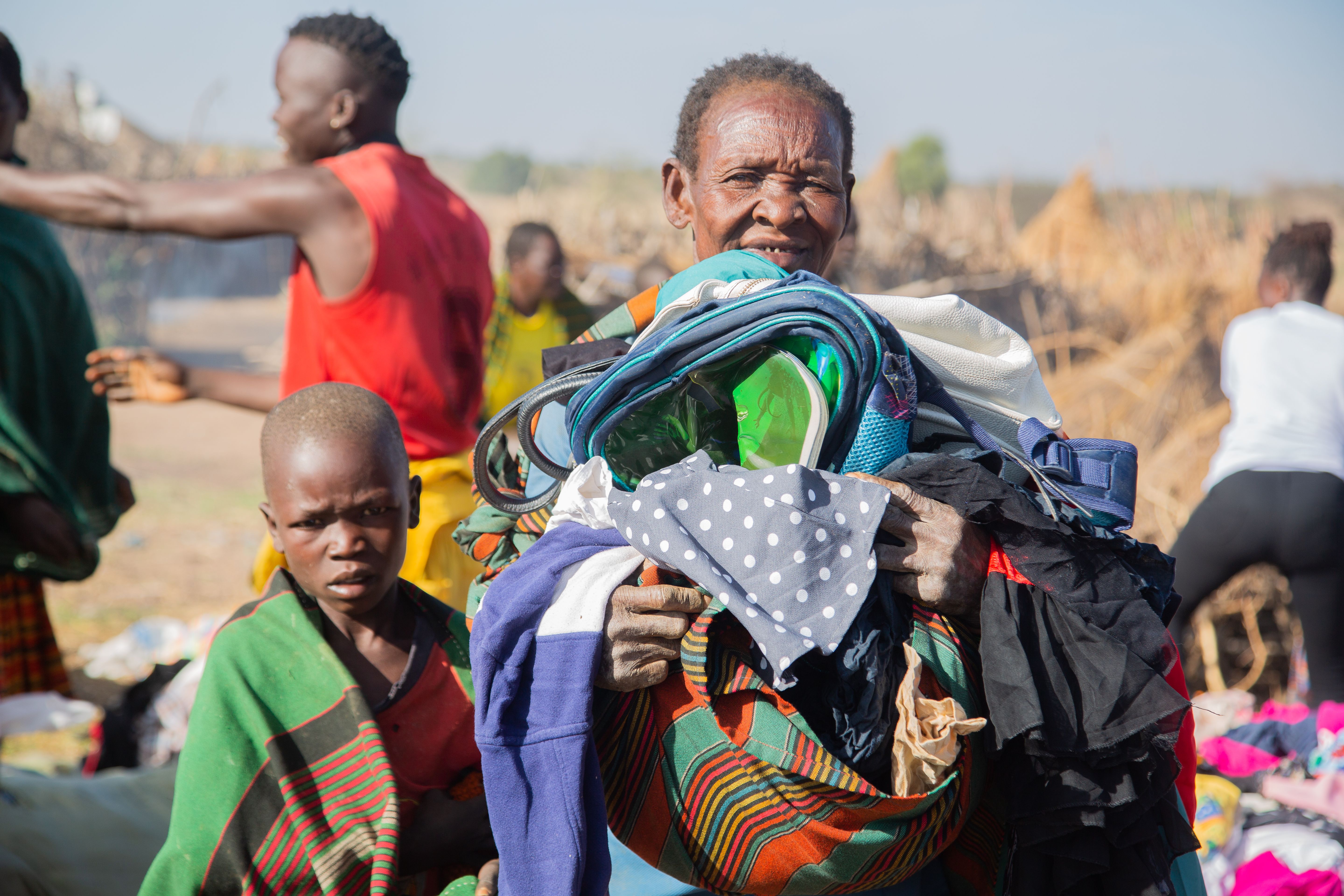 African Community Sharing Clothes Outdoors · Free Stock Photo