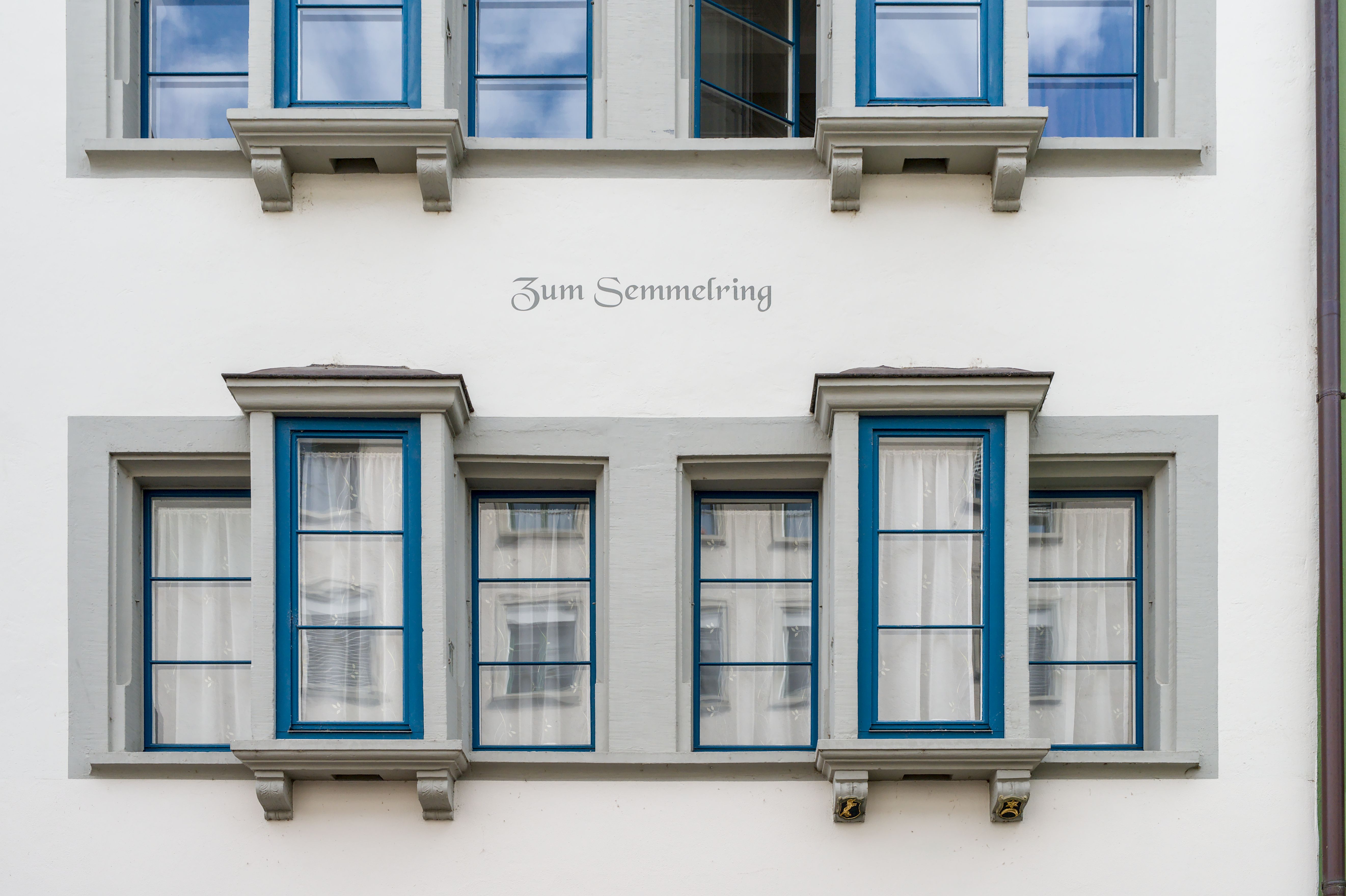 Charming Blue-Framed Windows in Swiss Architecture · Free Stock Photo
