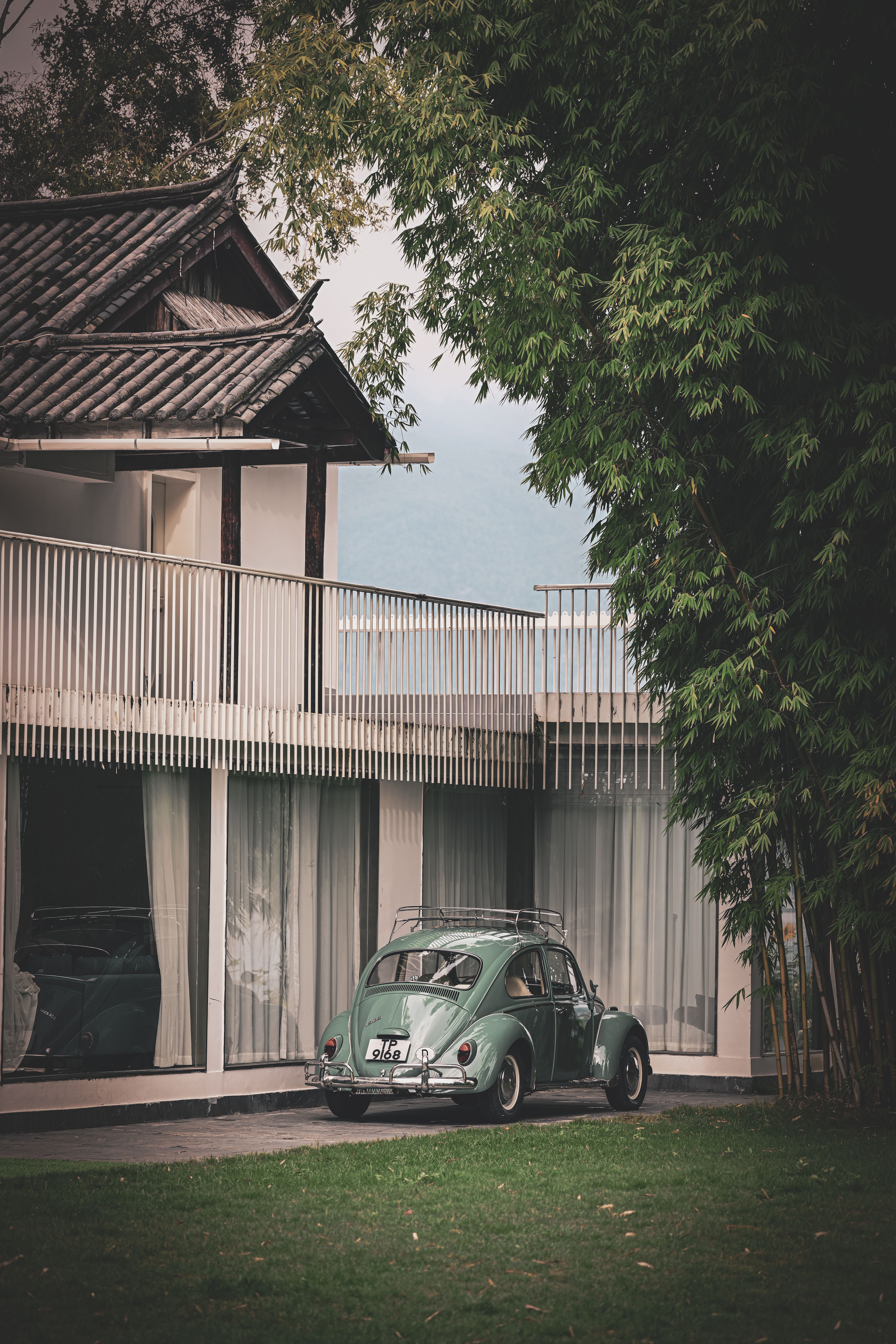 Vintage Car Parked Beside Traditional House in Yunnan · Free Stock Photo