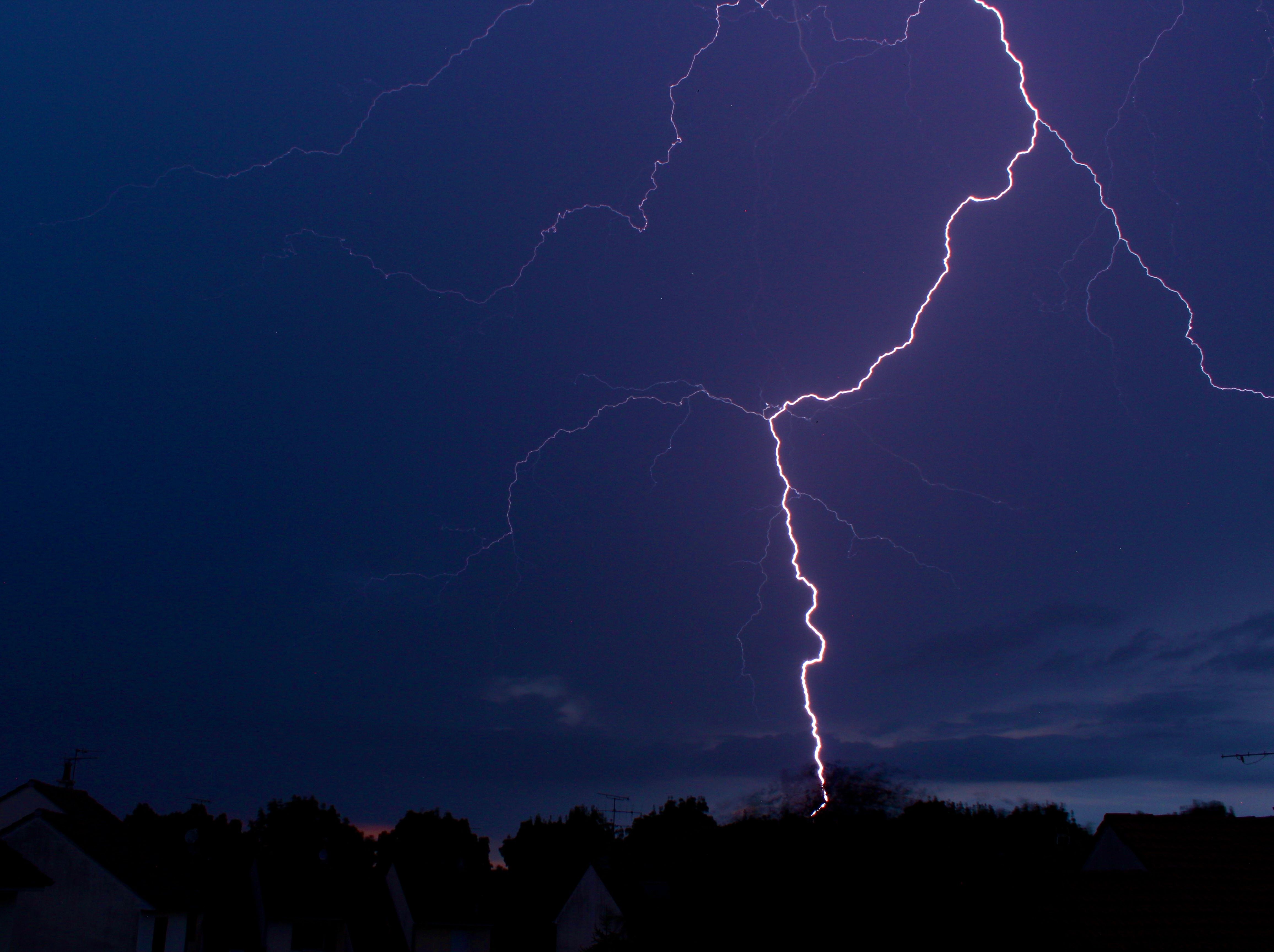 Dramatic Lightning Strike Over Houses at Night · Free Stock Photo