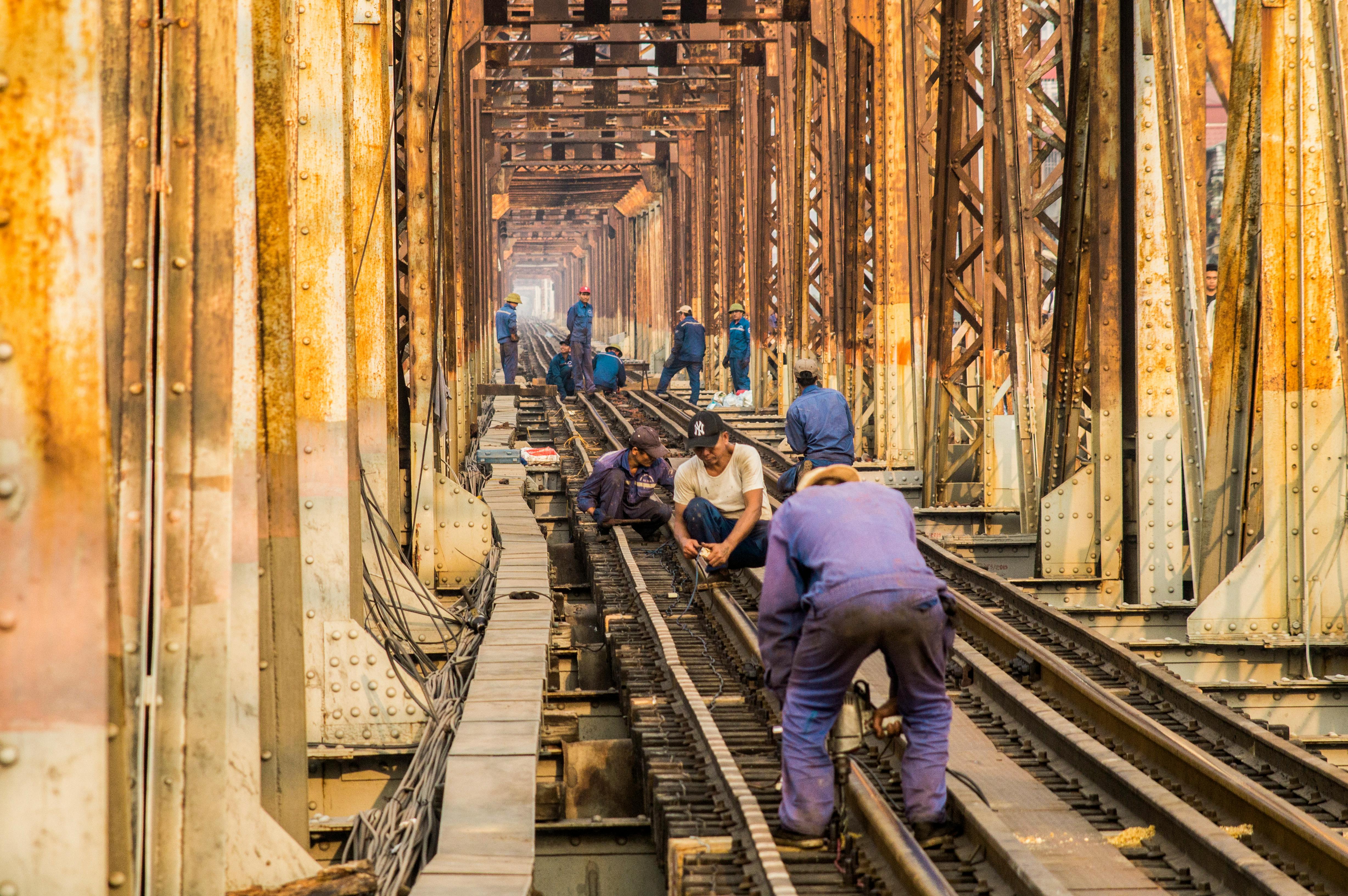 Anonymous men working on railway station · Free Stock Photo