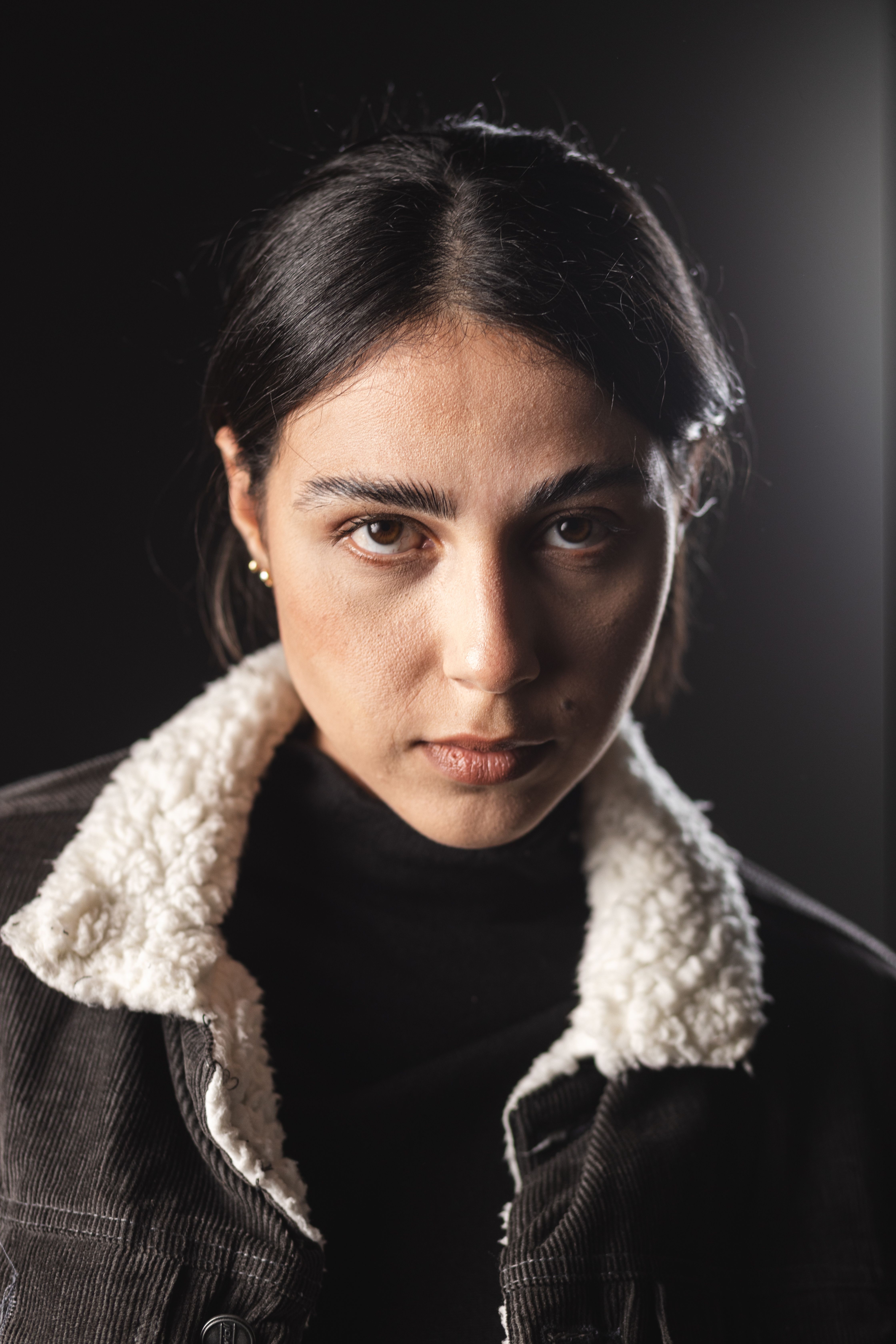 Intense Portrait of a Young Woman in Warm Lighting · Free Stock Photo