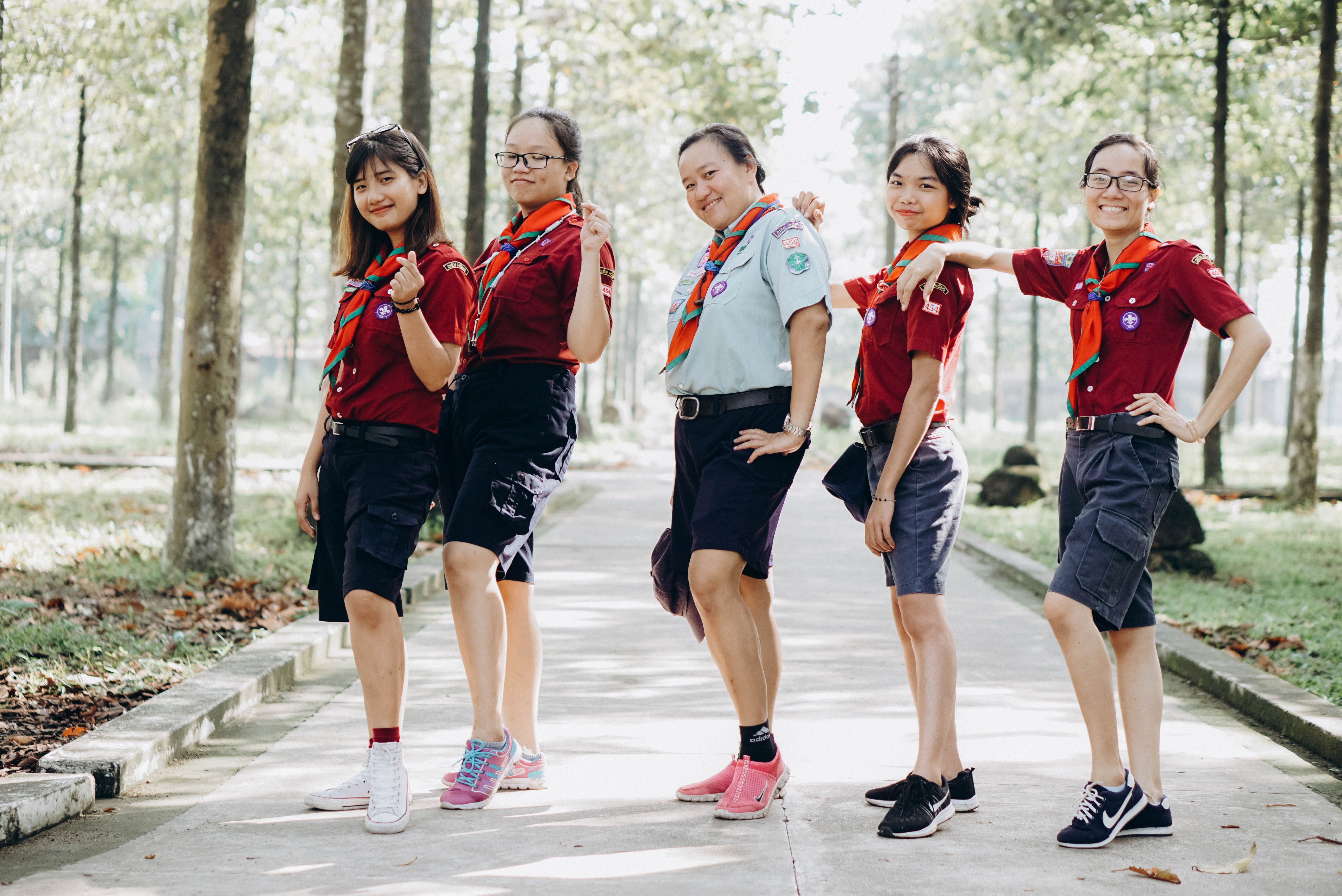 Teen Scouts Posing in Sunny Forest Pathway · Free Stock Photo