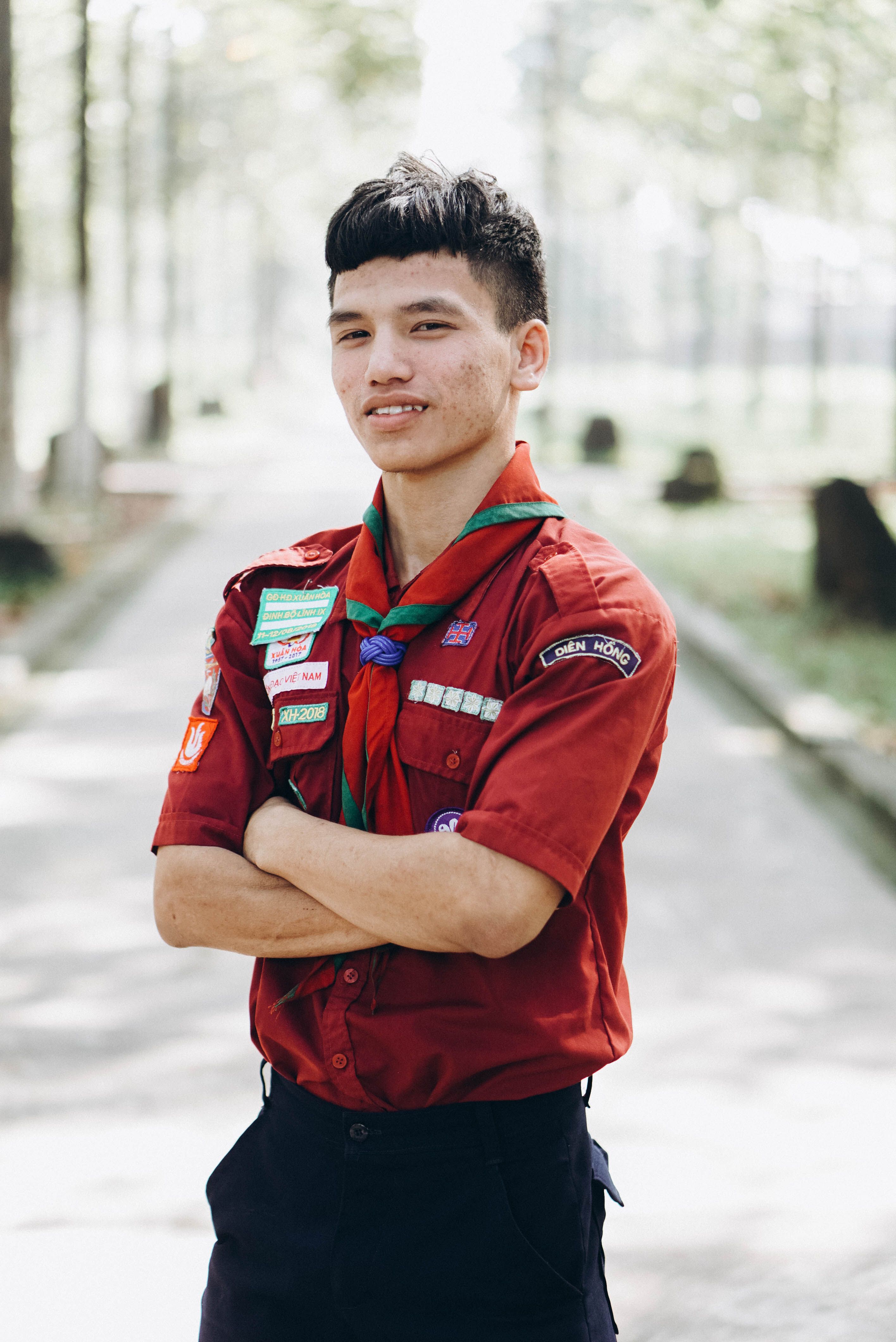 Young Scout in Uniform Posing Outdoors · Free Stock Photo