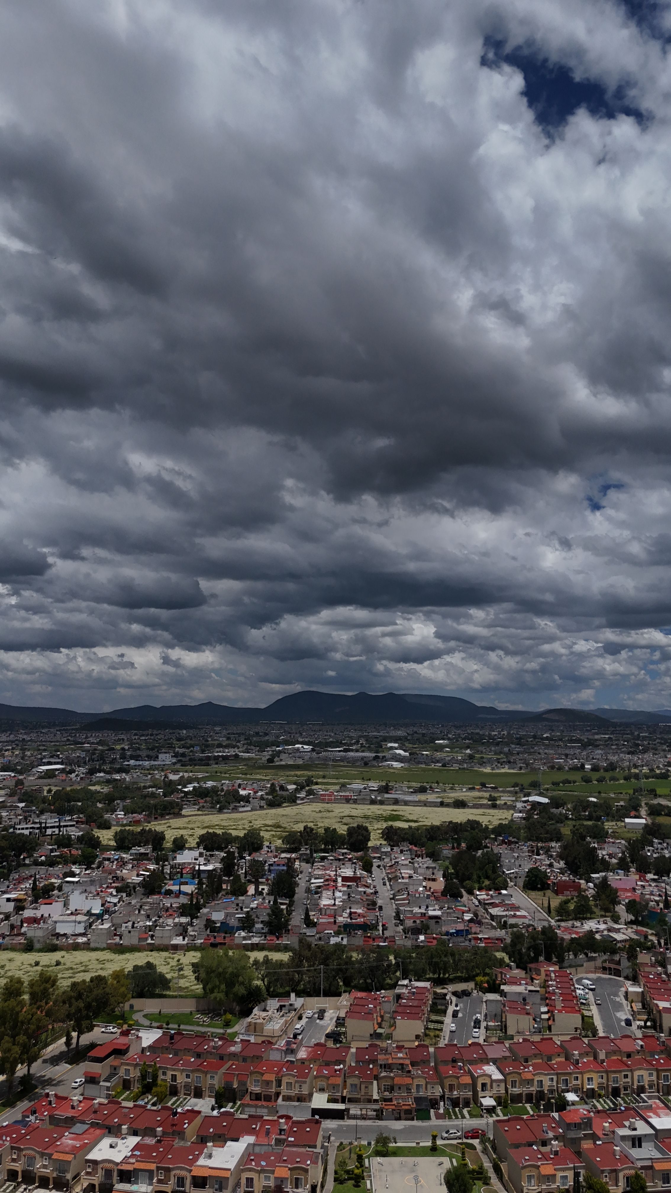 Aerial View of Cloudy Skies Over Mexican Cityscape · Free Stock Photo