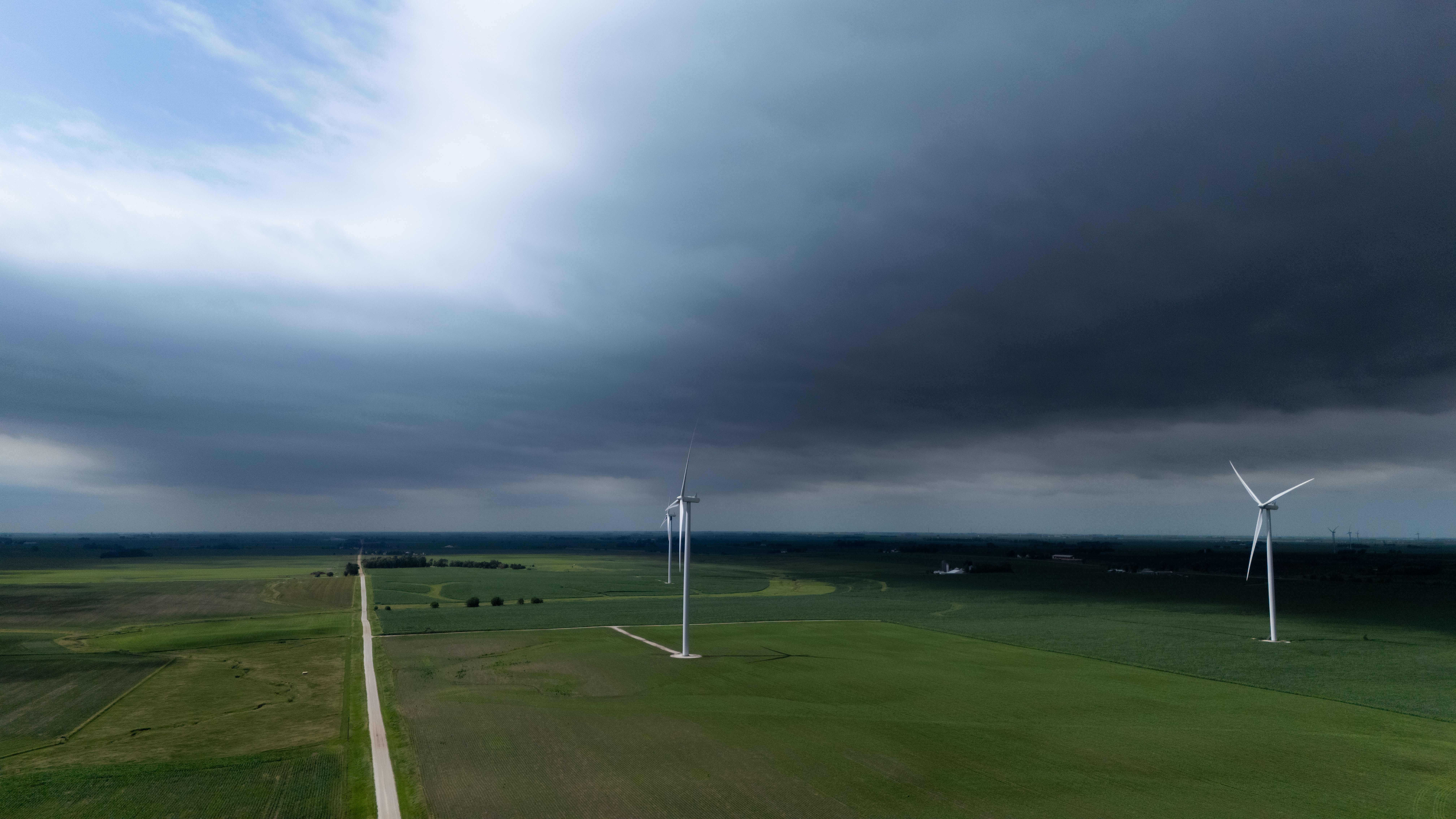 Stormy Sky Over Wind Turbines in Green Fields · Free Stock Photo