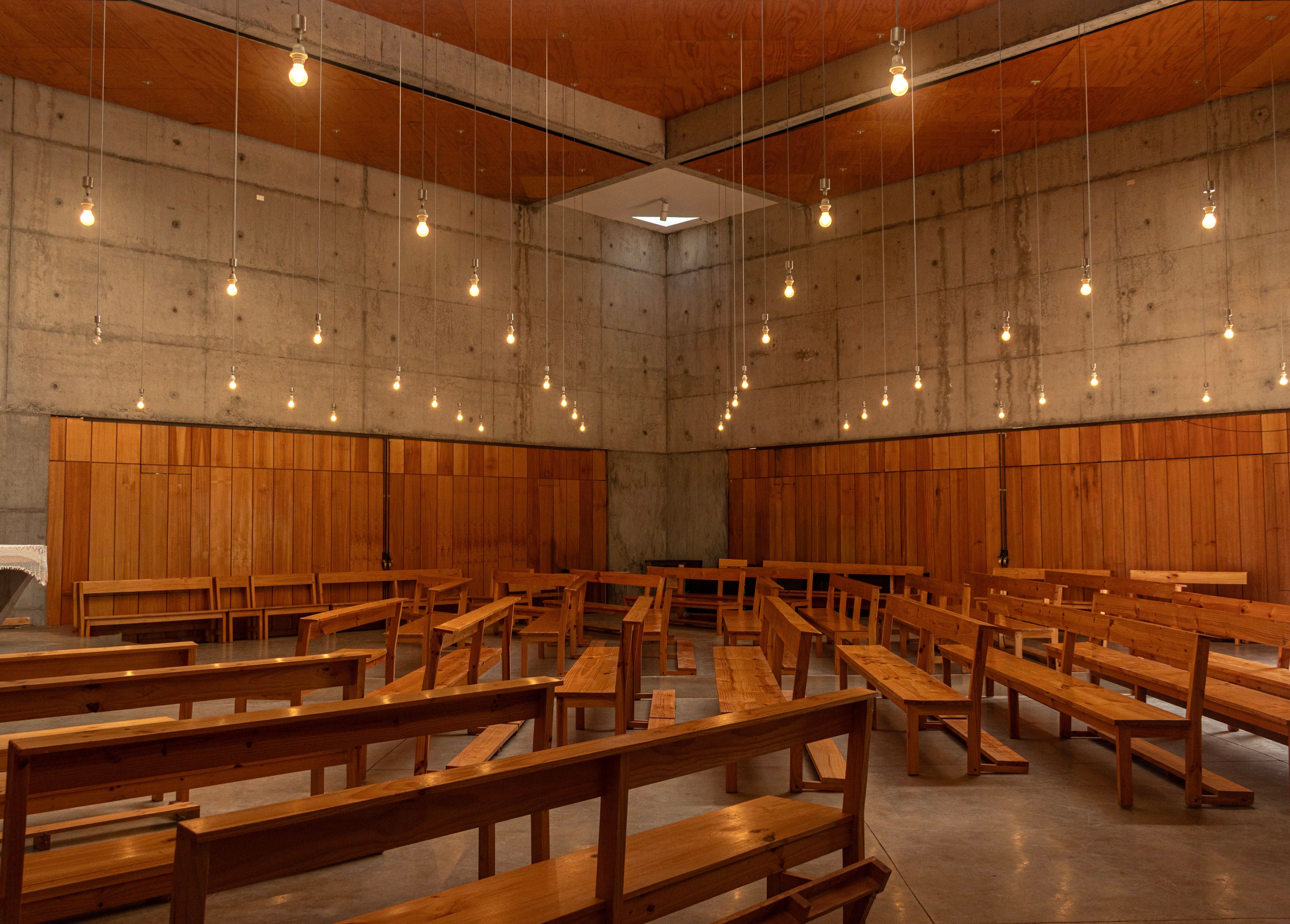Cozy Church Interior with Hanging Lights · Free Stock Photo
