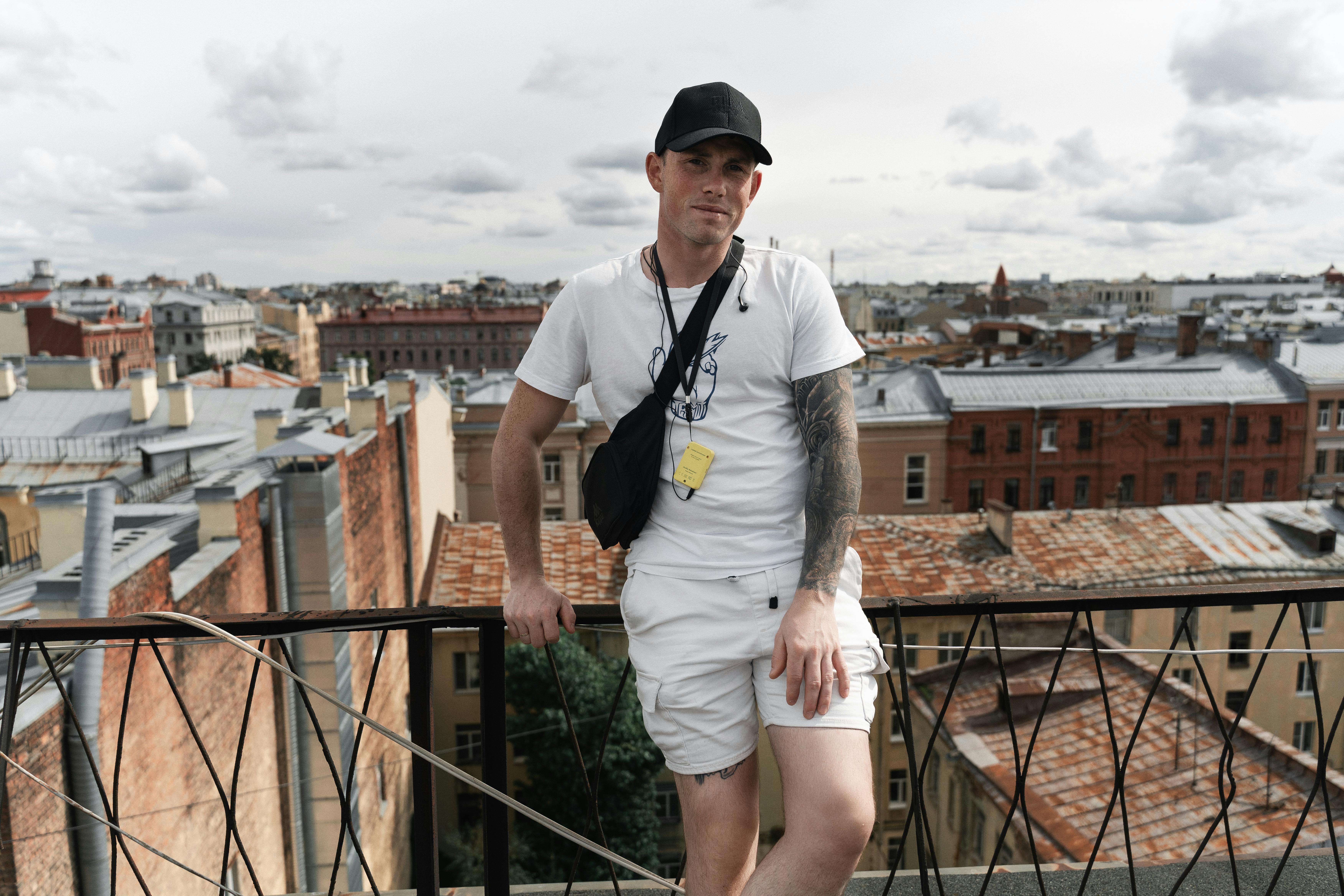 Man on Rooftop with Urban Cityscape Background · Free Stock Photo
