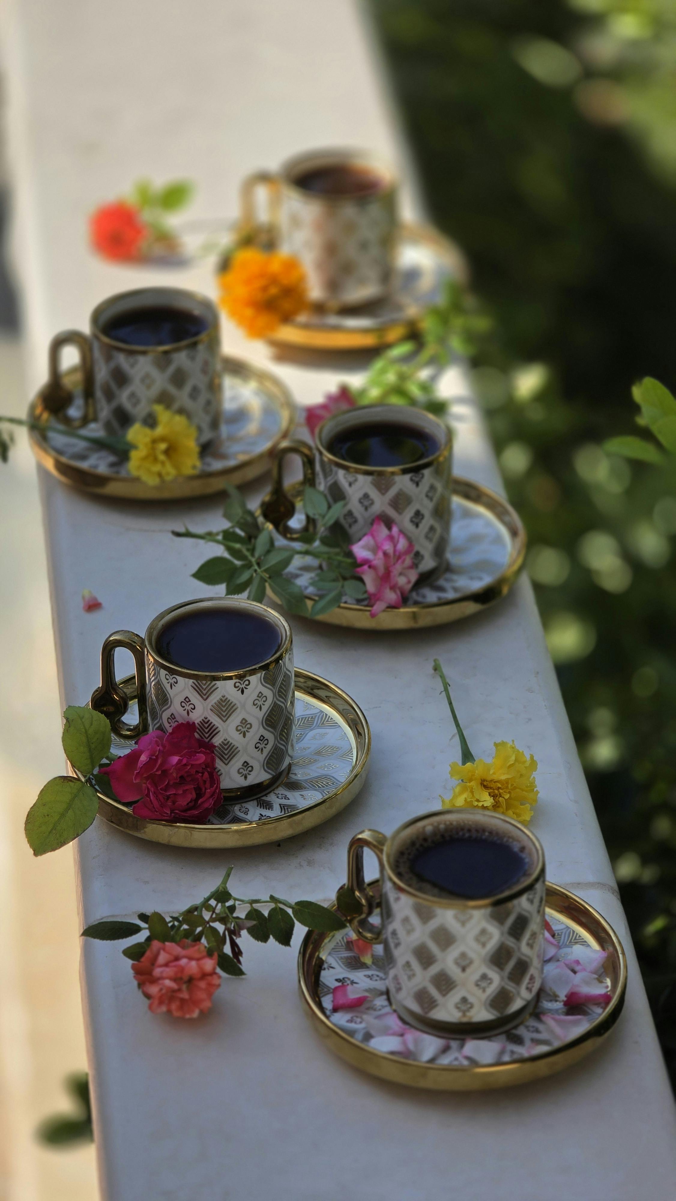 Elegant Coffee Cups with Colorful Floral Decor · Free Stock Photo