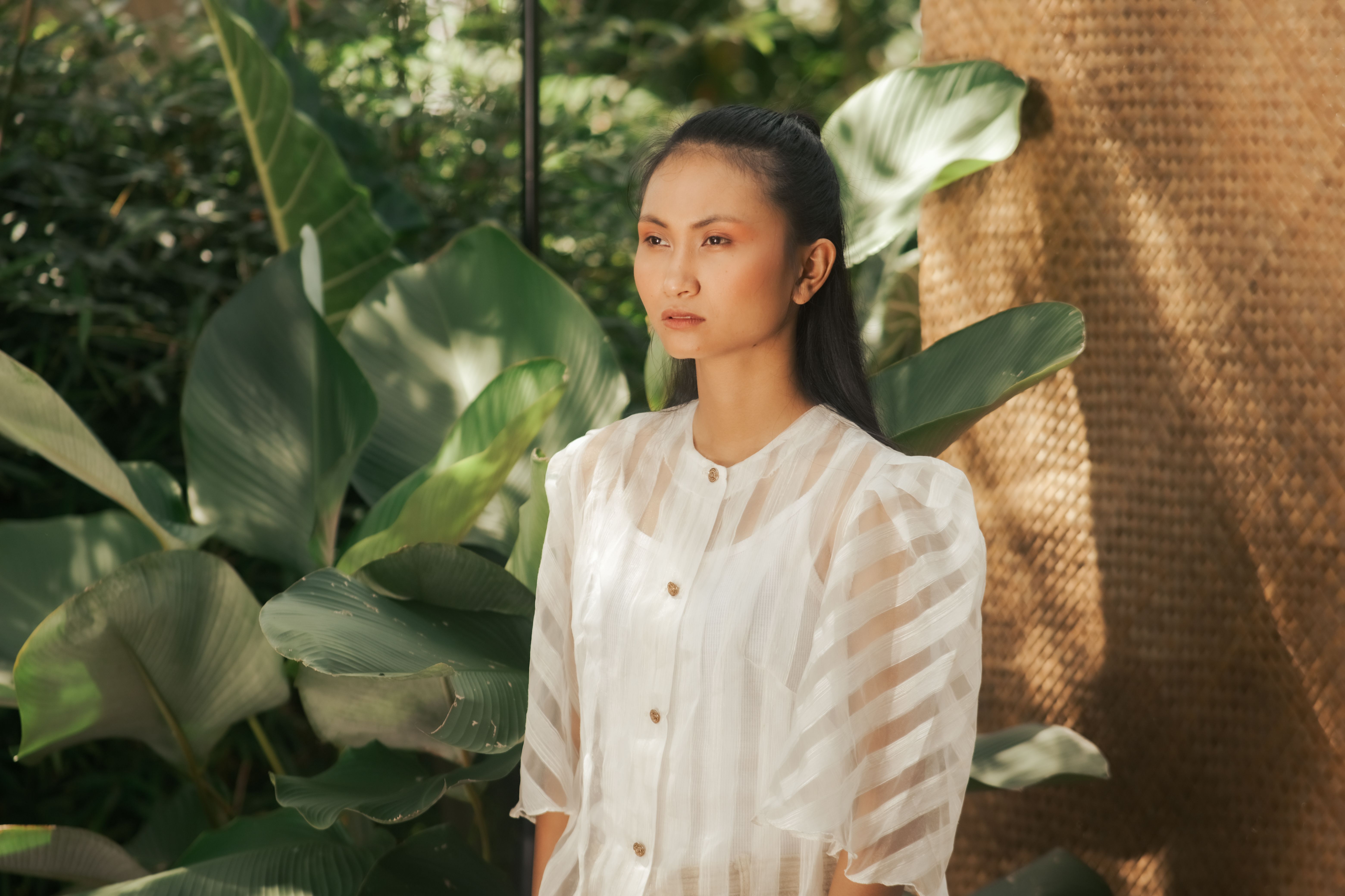 Elegant Woman Standing Amidst Lush Greenery · Free Stock Photo