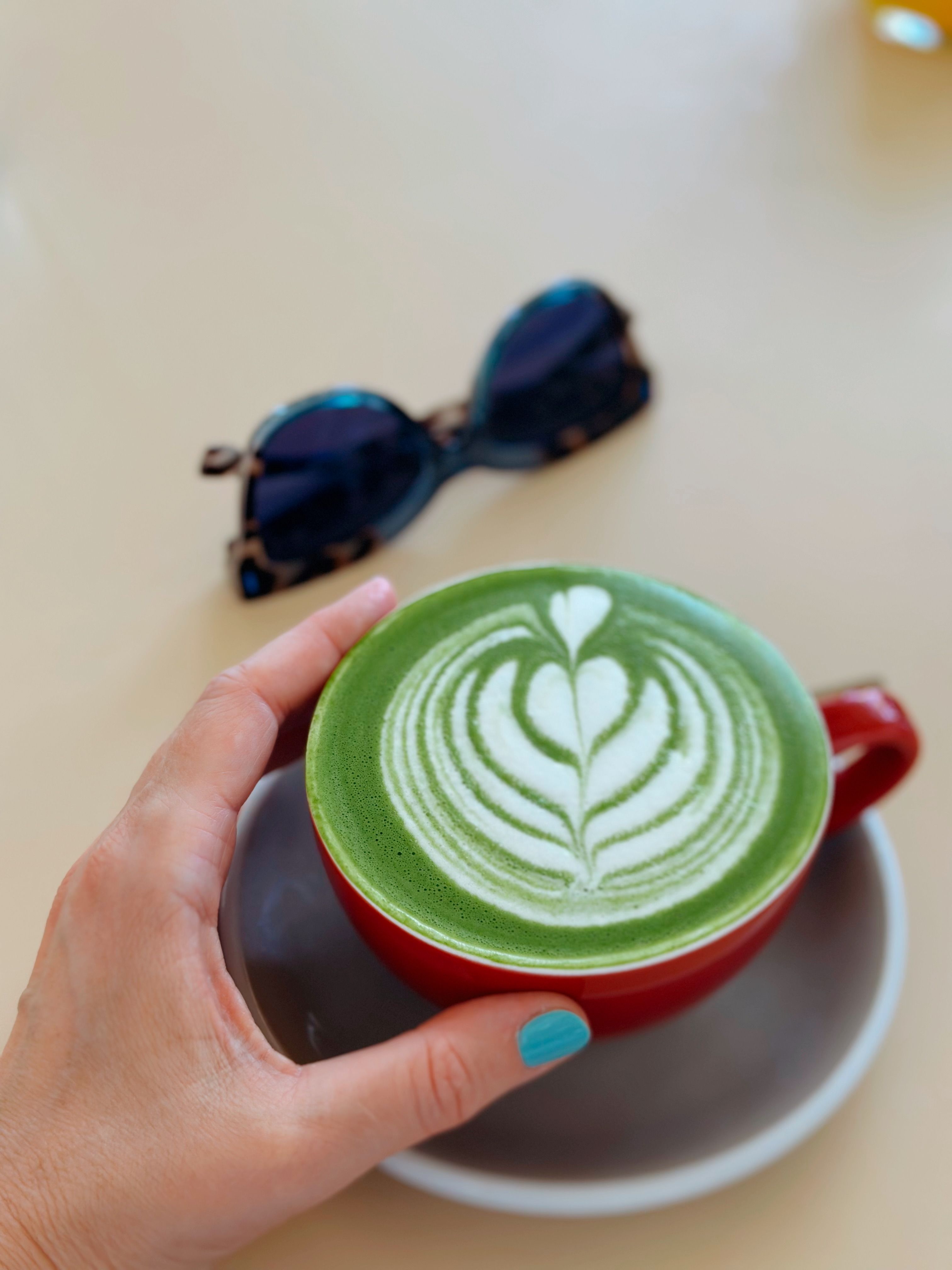 Vibrant Matcha Latte with Heart Art in Red Cup · Free Stock Photo
