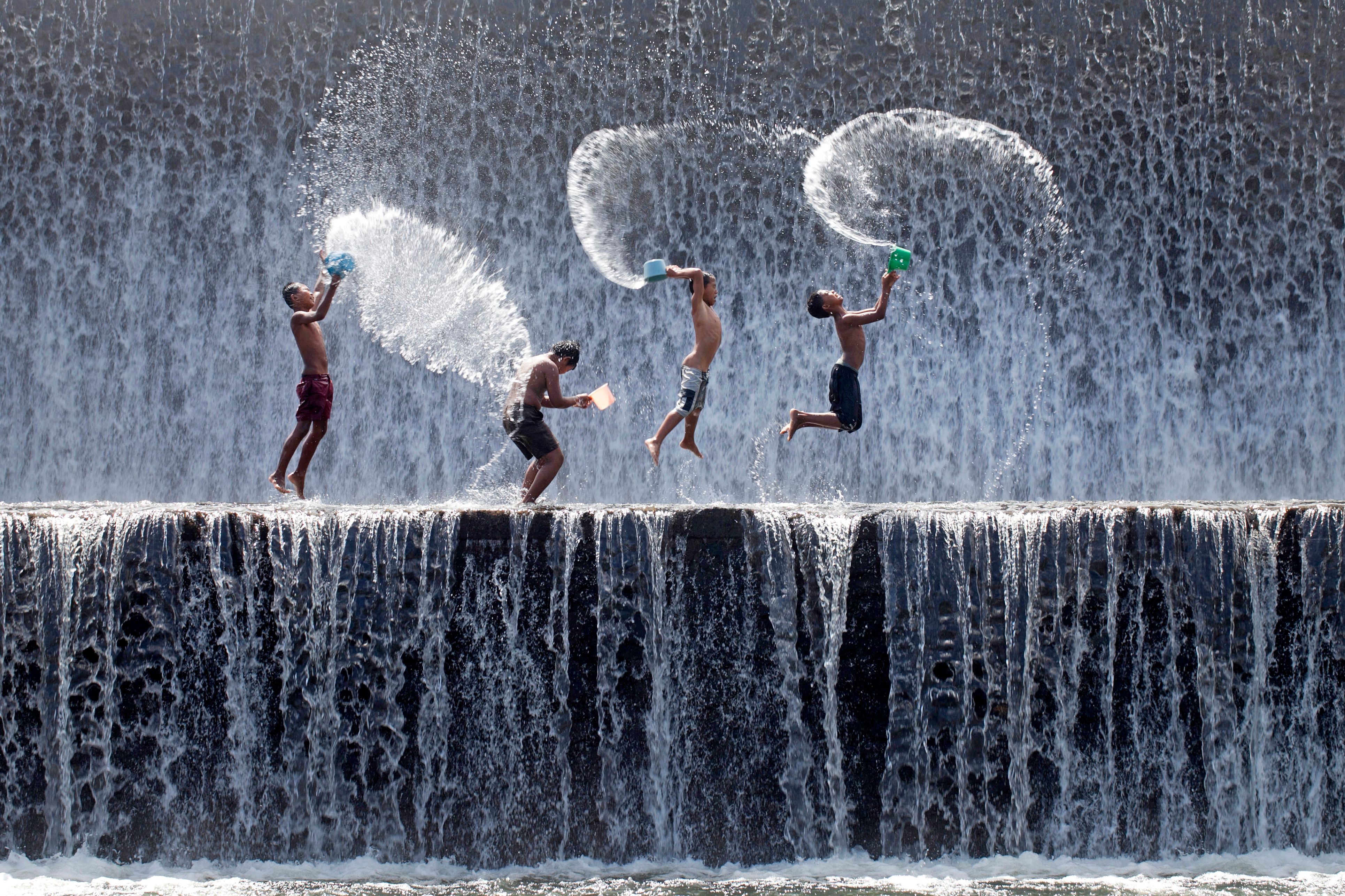 Children Playing in Waterfall on Sunny Day · Free Stock Photo