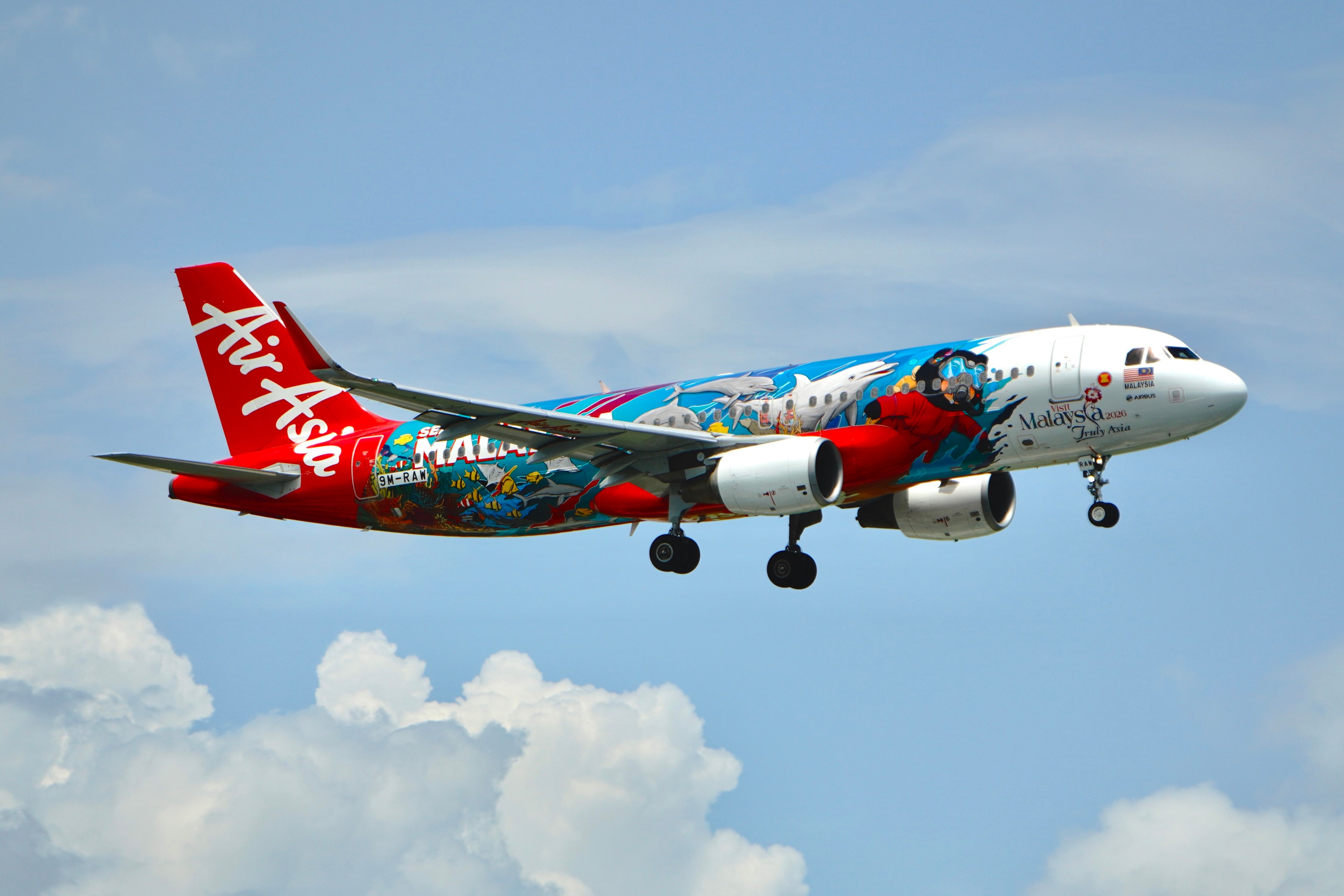 Colorfully Decorated AirAsia Plane Mid-Flight · Free Stock Photo