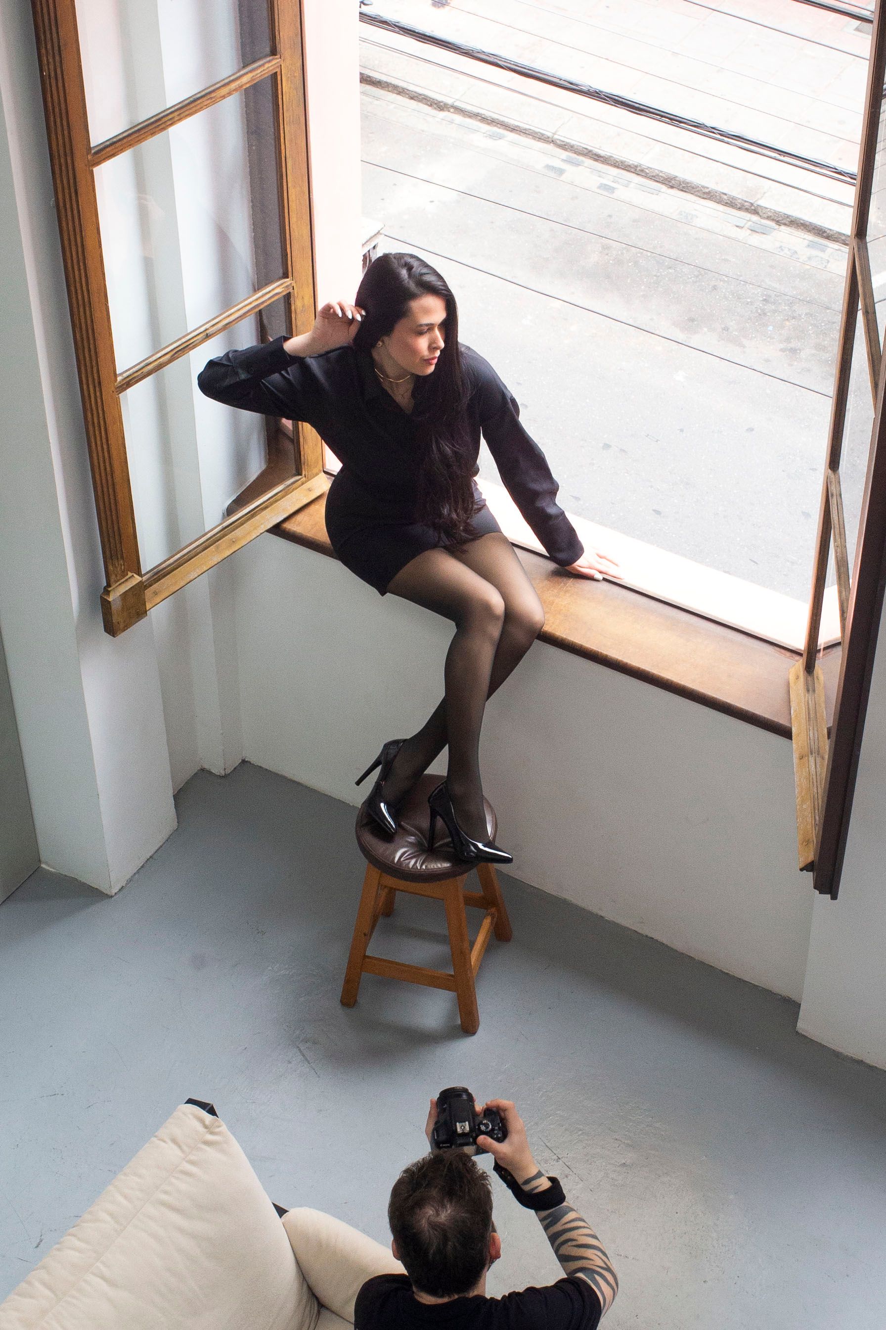 Professional Photographer Capturing Window Portrait · Free Stock Photo