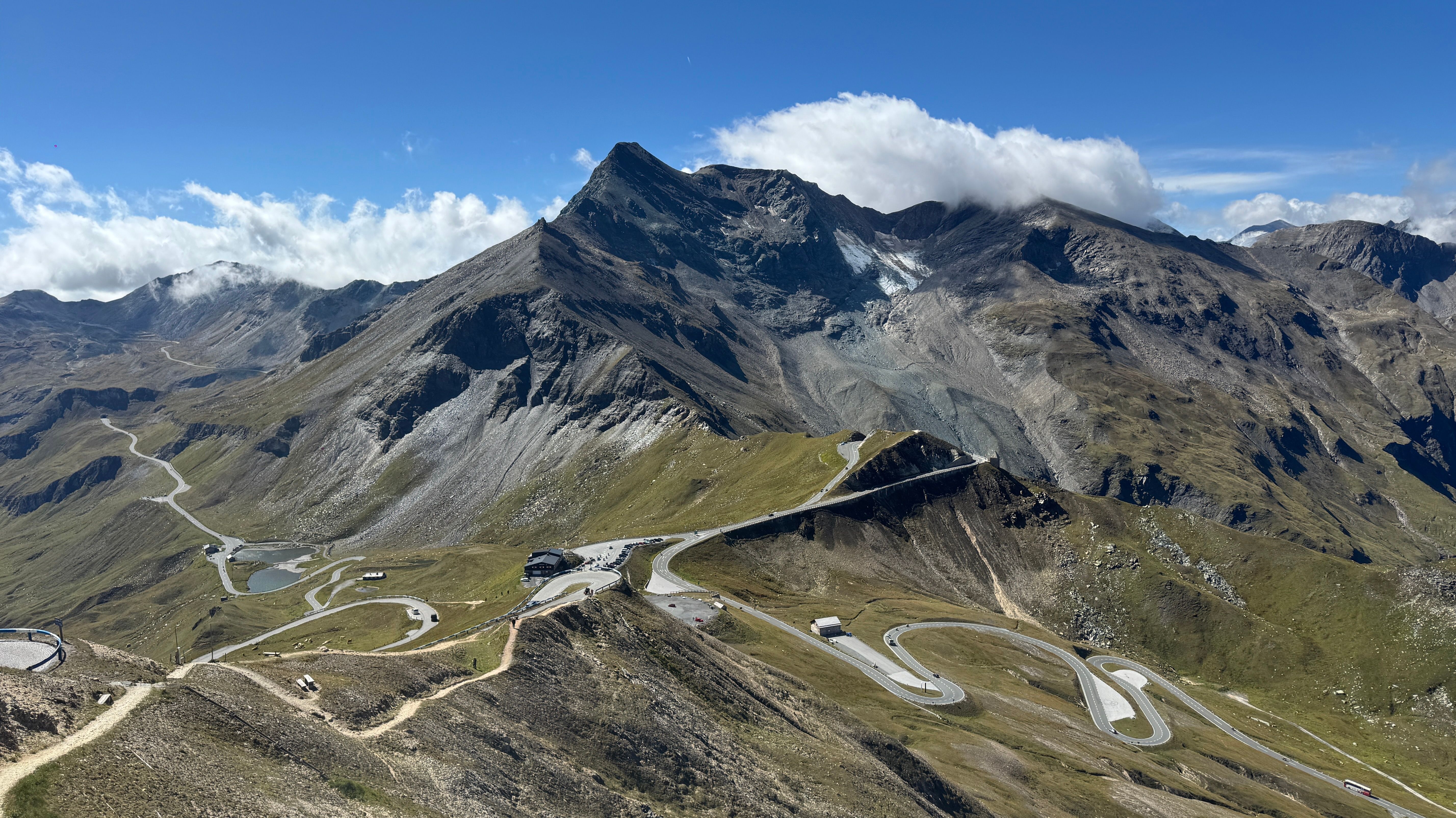 Alpine road winding through high mountain peaks · Free Stock Photo