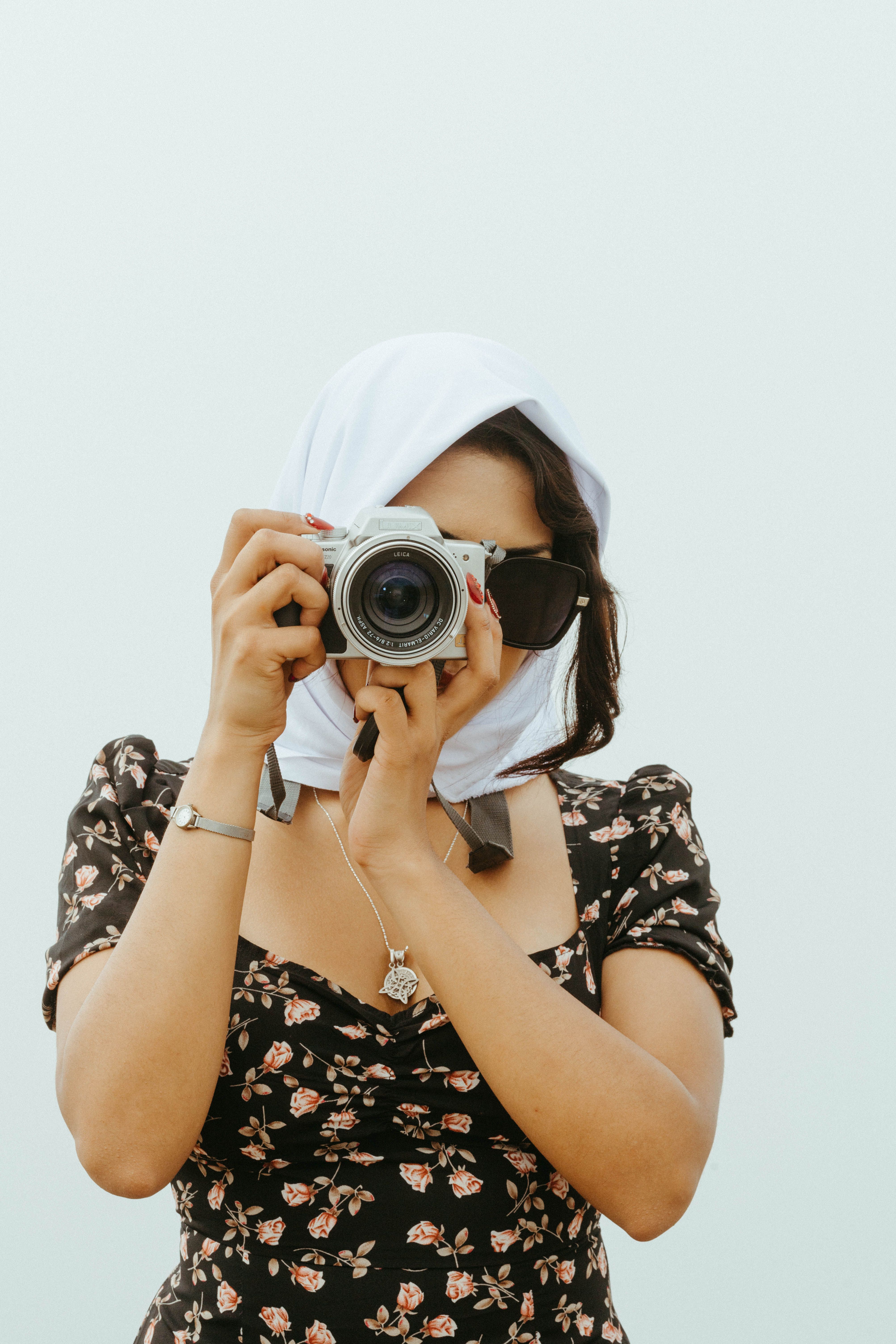 A woman taking a picture with her camera · Free Stock Photo
