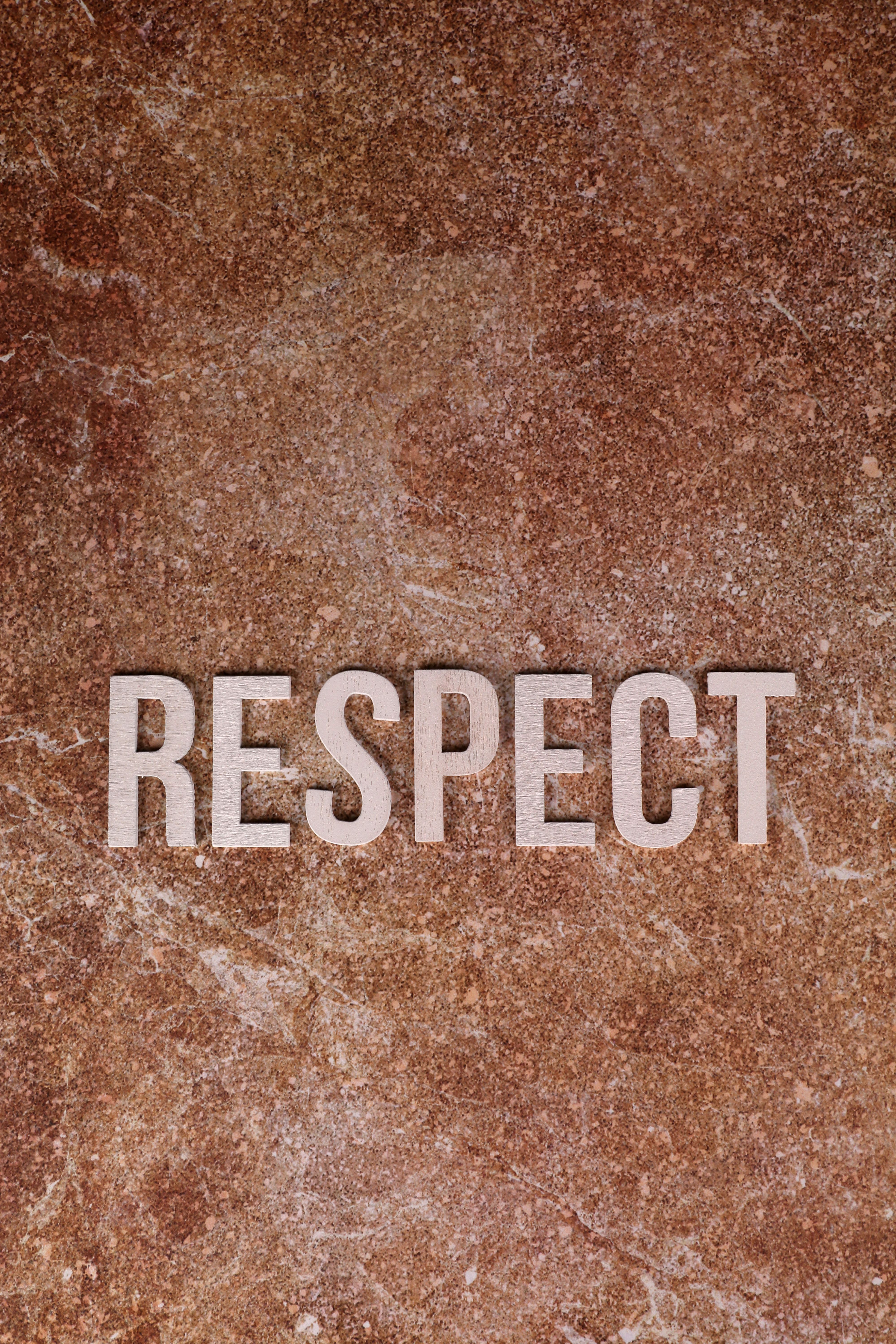 Respect Text on Brown Marble Background · Free Stock Photo