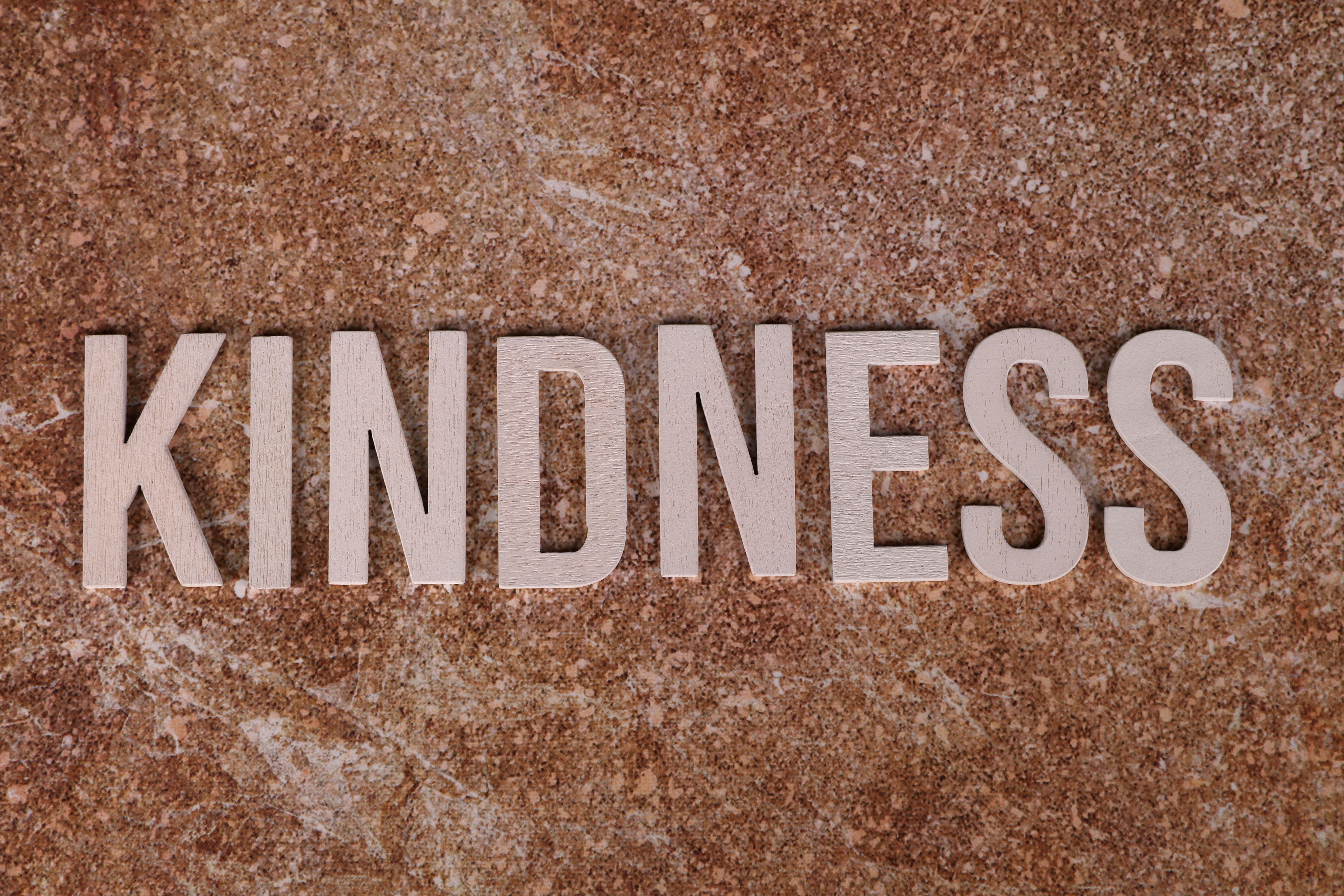 Wooden Letters Spell 'Kindness' on Stone Background · Free Stock Photo