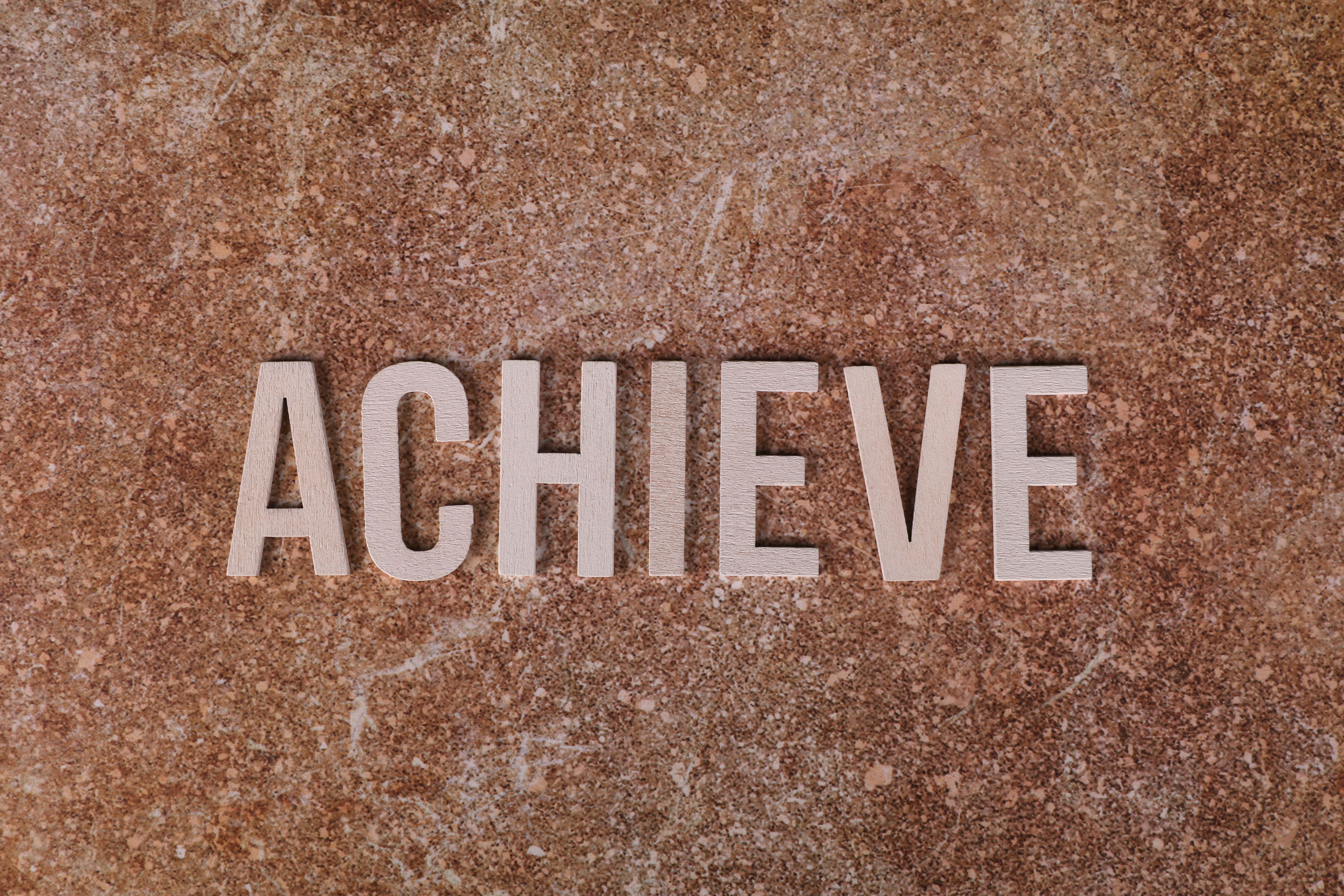 Motivational Word Art on Textured Surface · Free Stock Photo