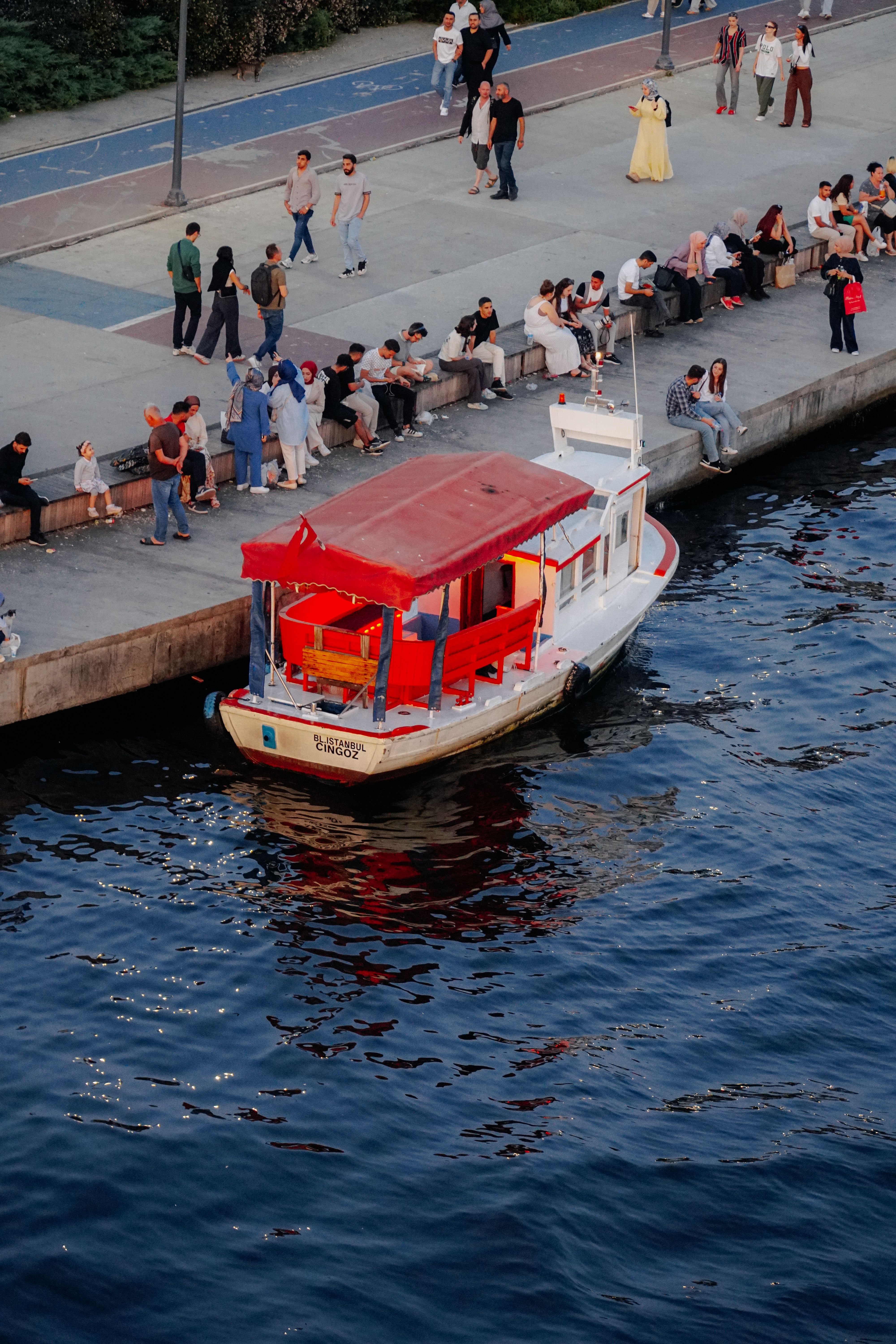 Crowded Promenade by the Waterfront with Boat · Free Stock Photo