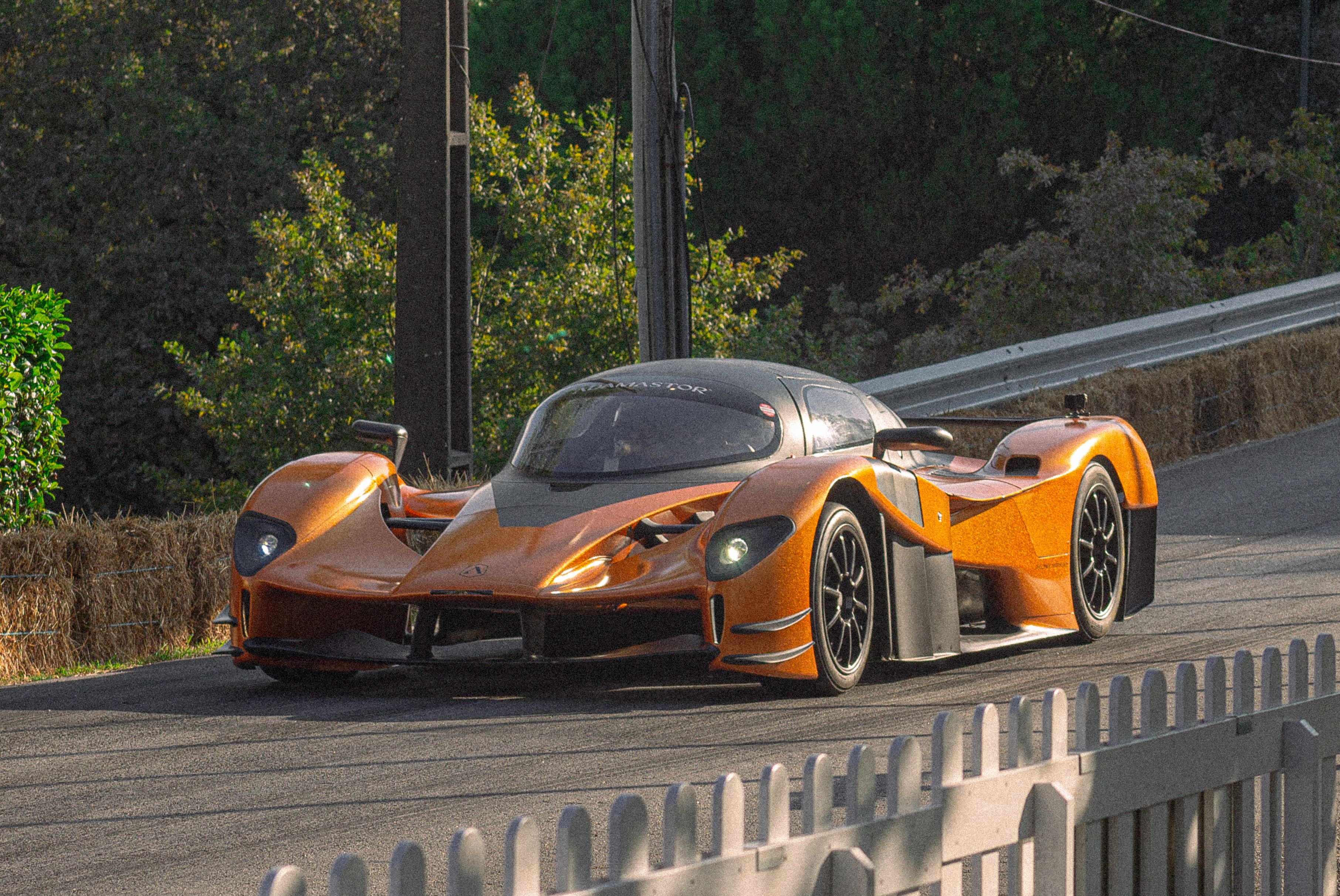 Sleek Hypercar on a Sunlit Road in Portugal · Free Stock Photo