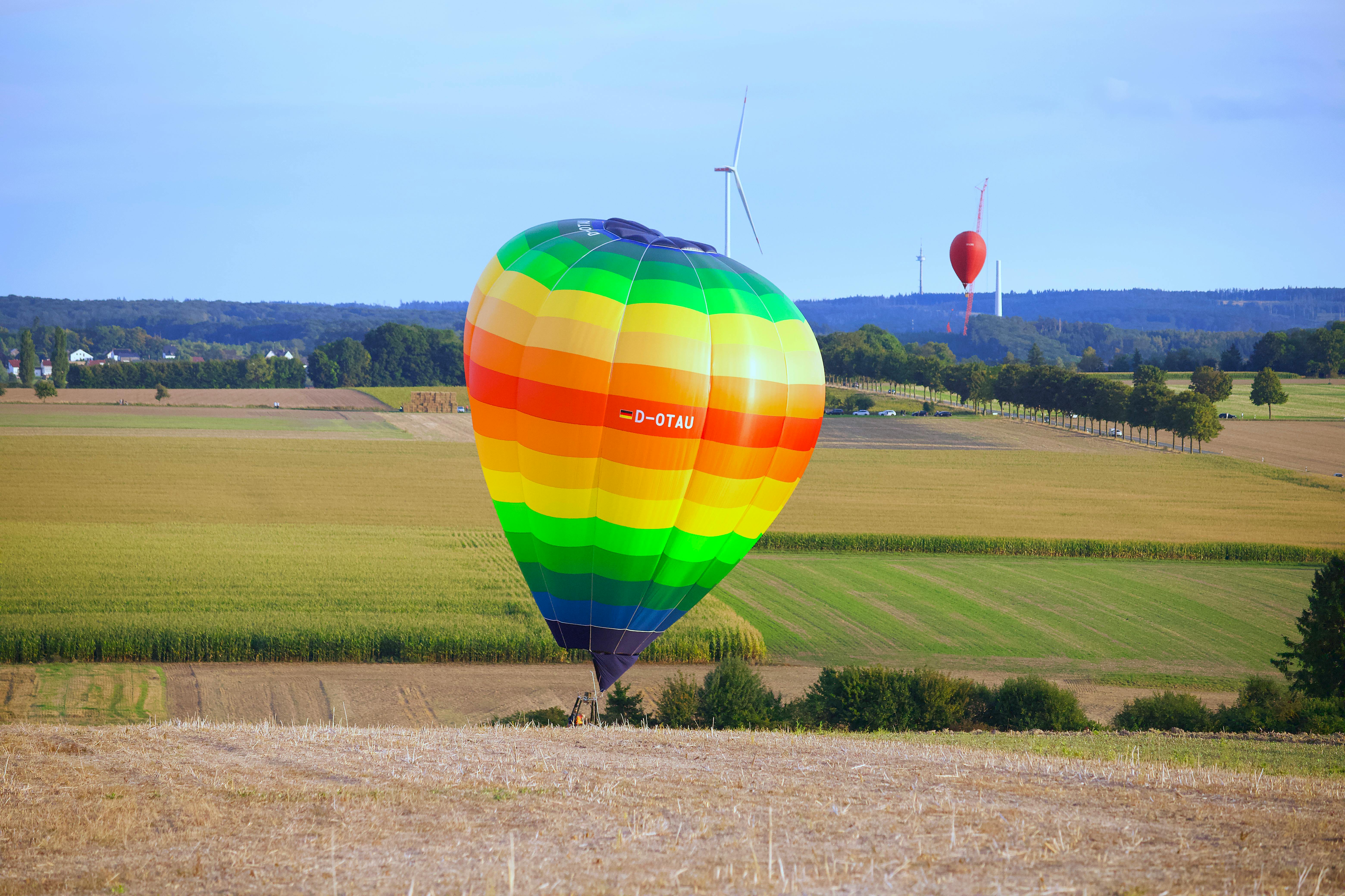 Colorful Hot Air Balloon in Open Field Landscape · Free Stock Photo
