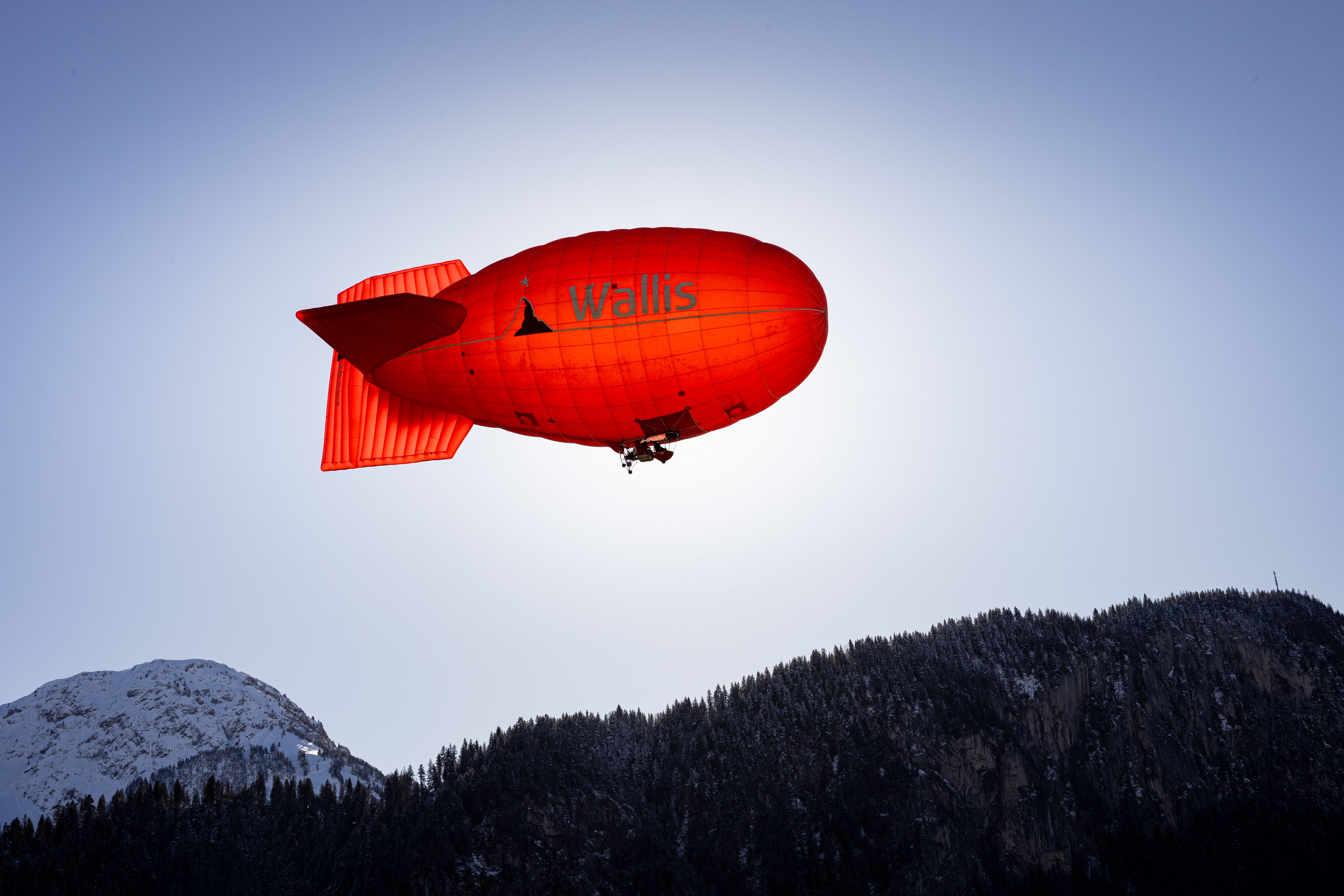 Red Blimp over Snowy Mountains at Château-d'Oex · Free Stock Photo