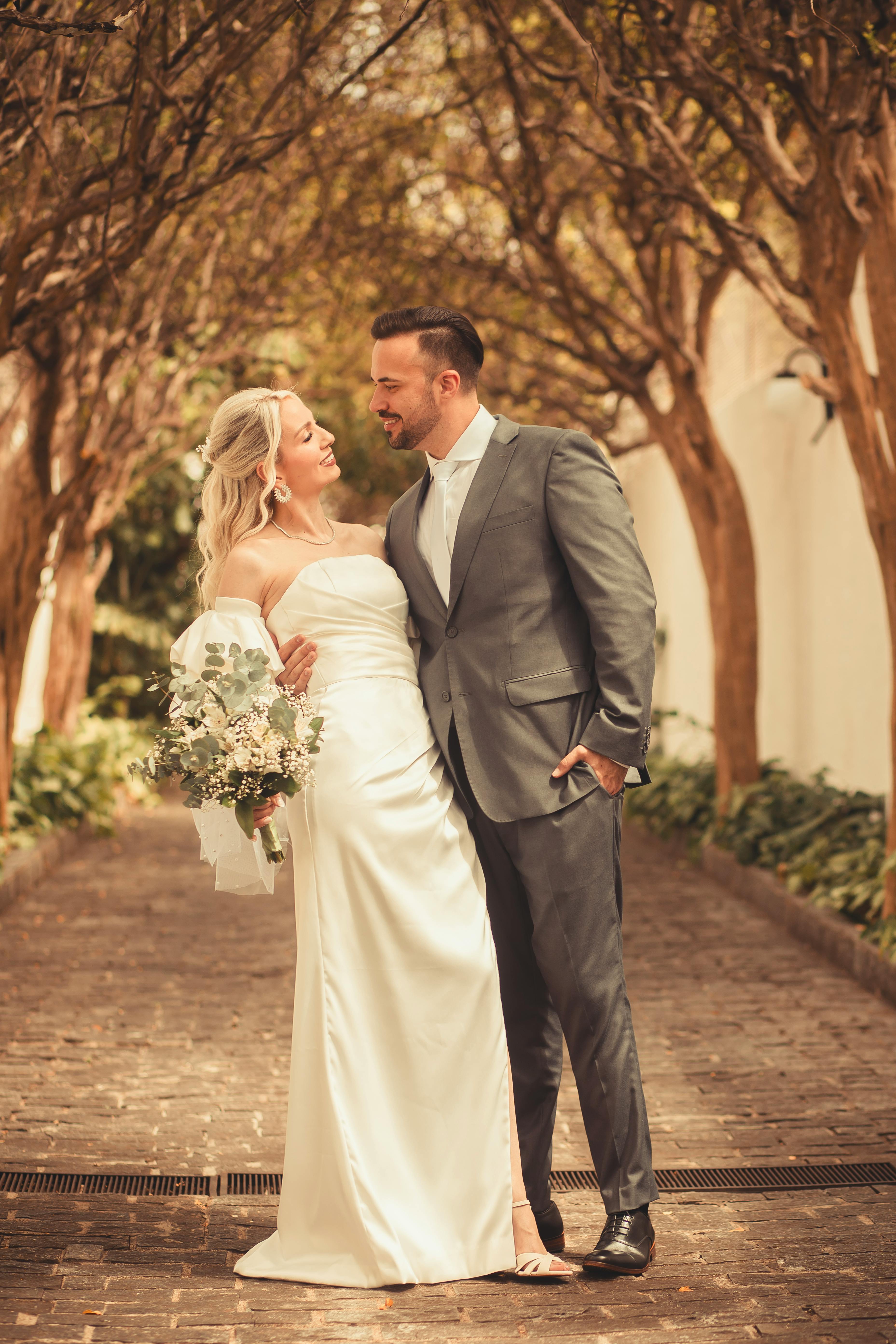 Romantic Wedding Couple in Scenic Garden Path · Free Stock Photo