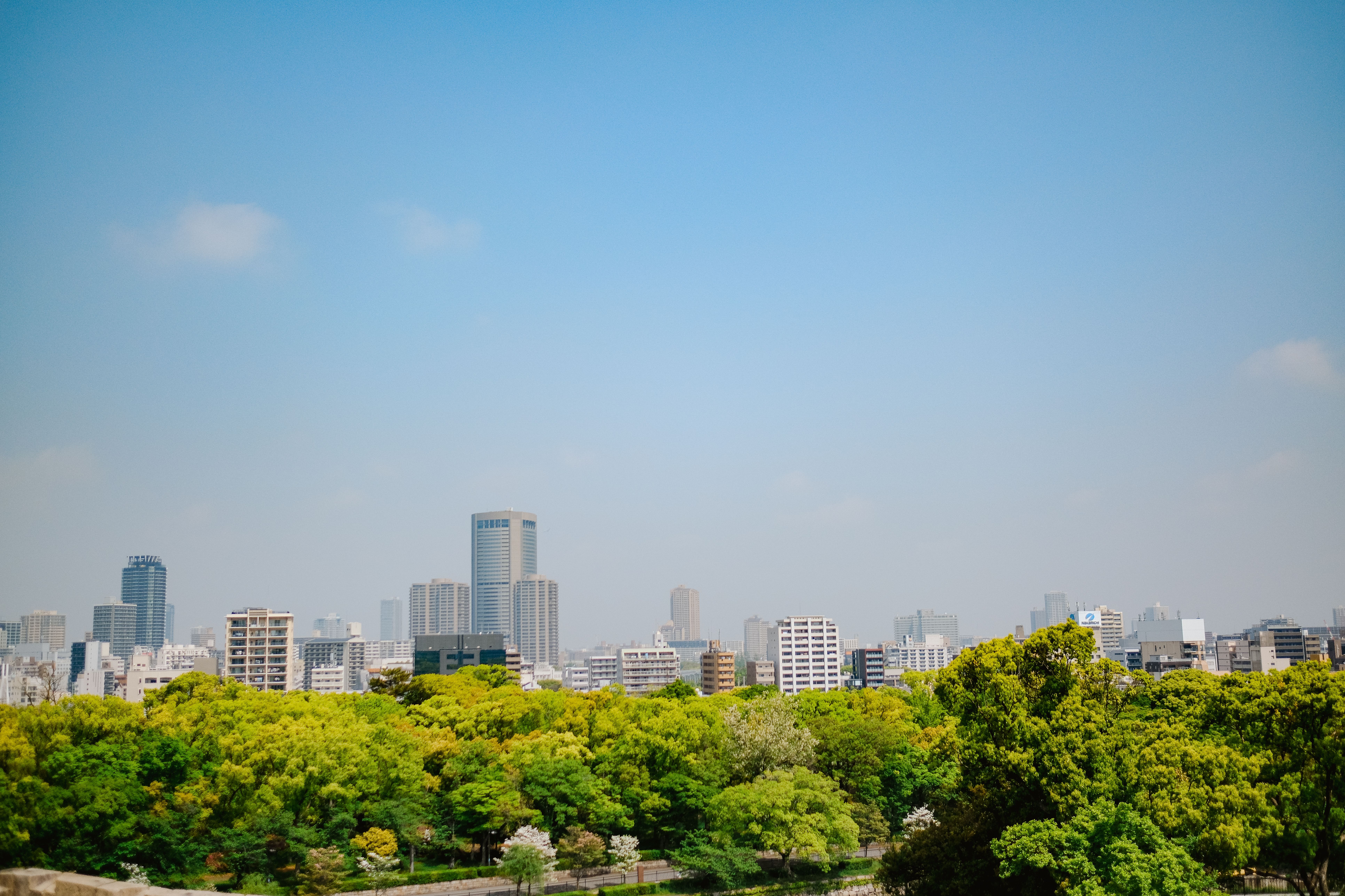 Vibrant City Skyline Against Clear Blue Sky · Free Stock Photo