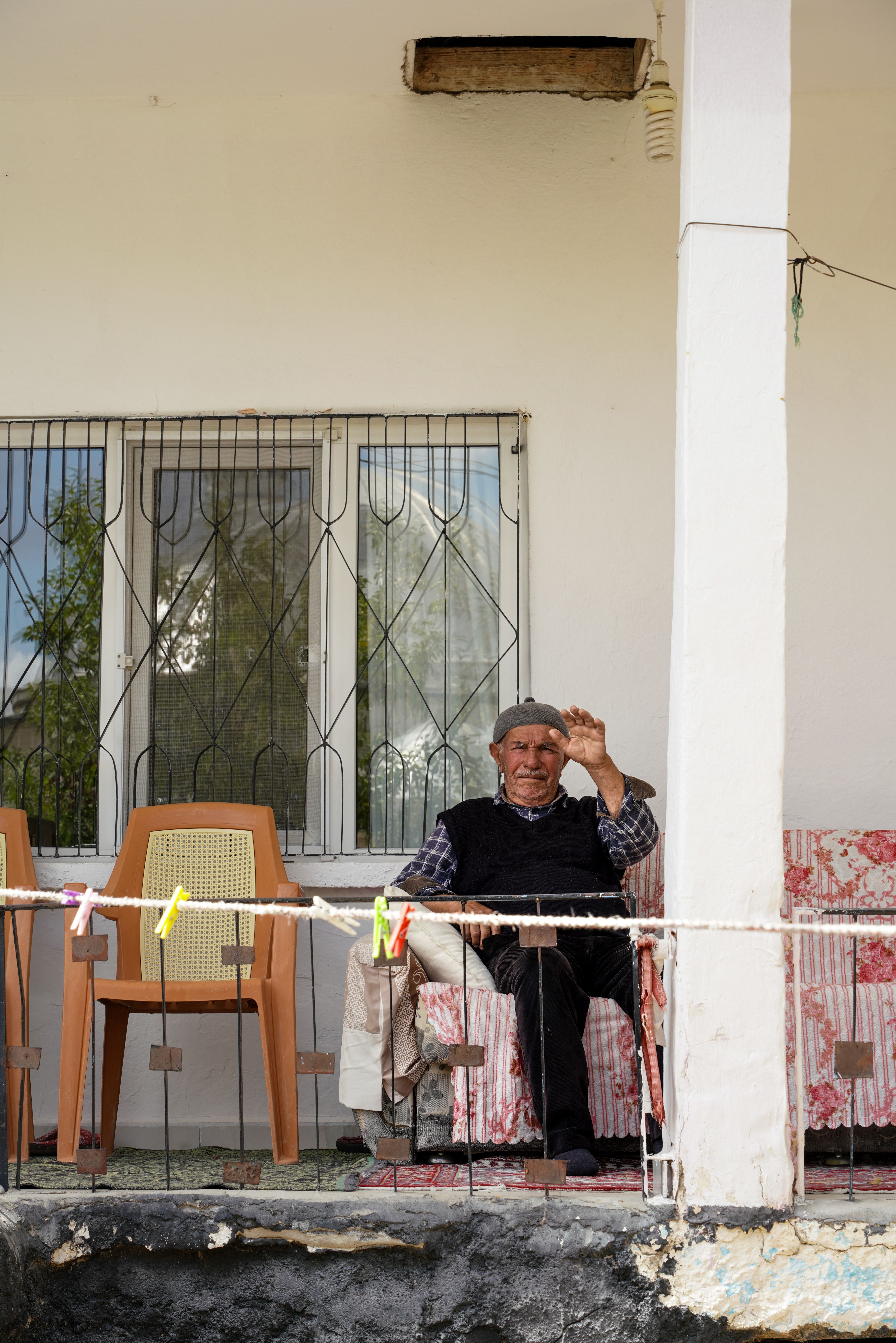 Elderly Man Sitting on Porch Waving Hello · Free Stock Photo