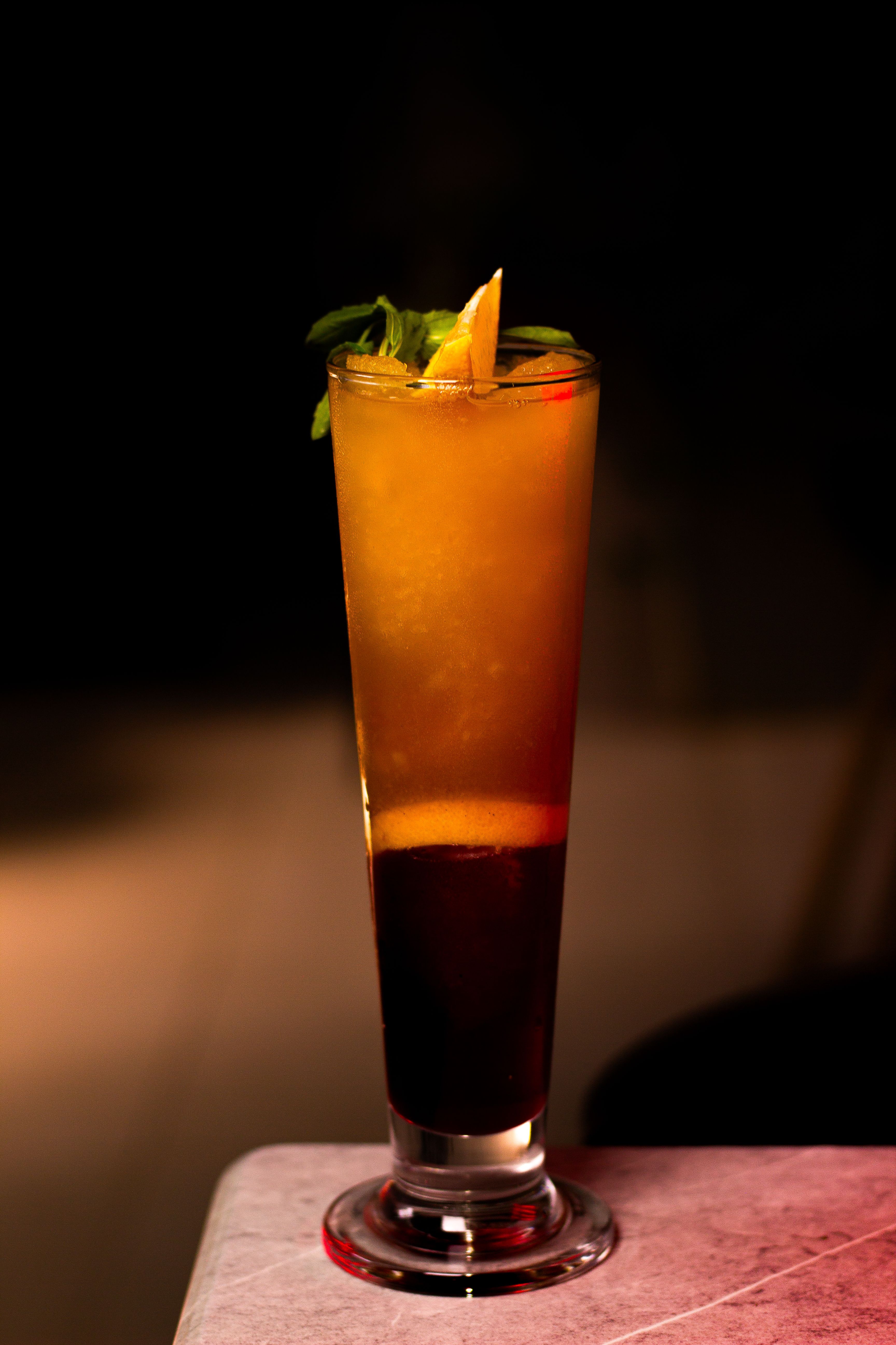 Elegant Layered Cocktail with Citrus Garnish · Free Stock Photo