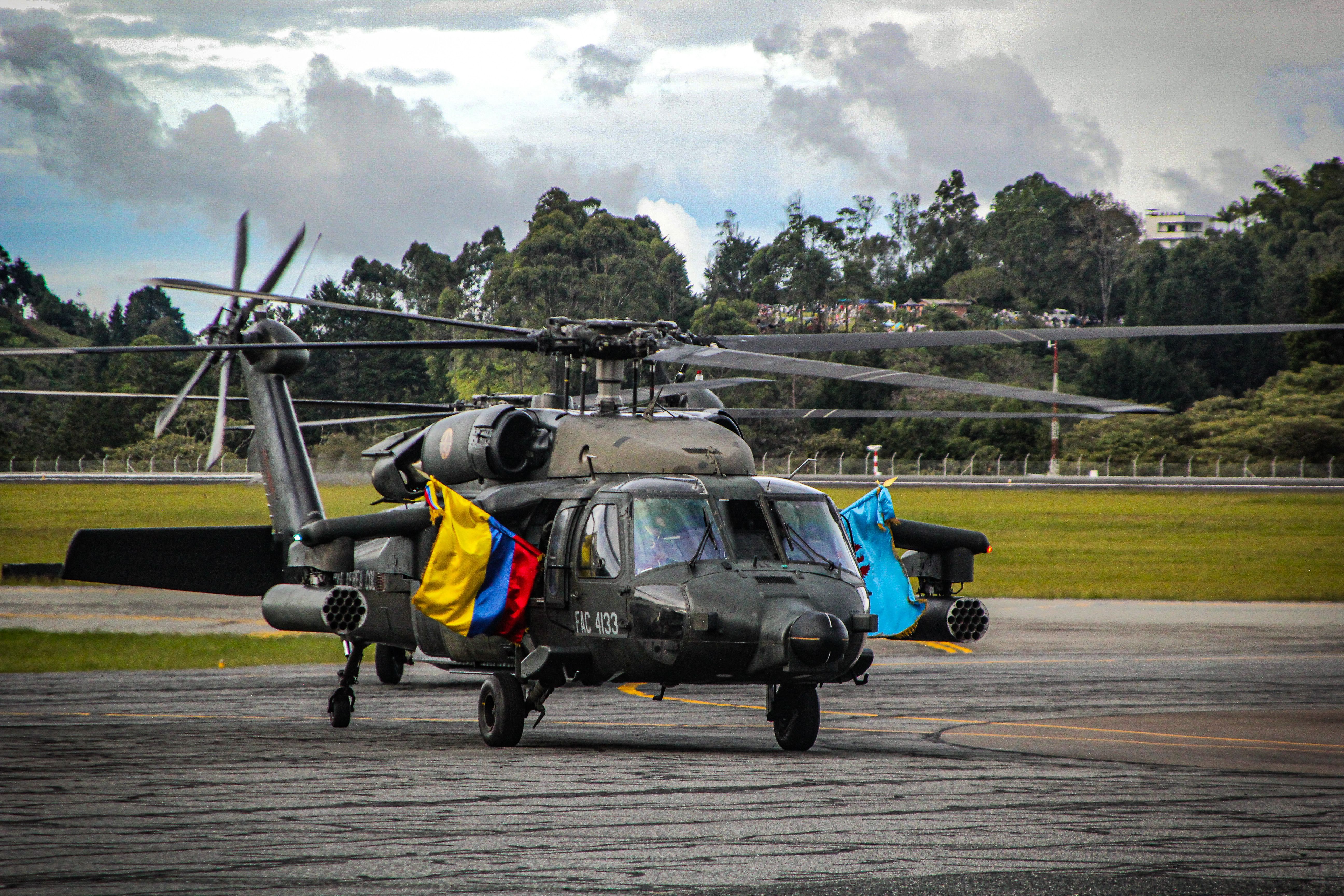 Military Helicopter on Airfield with Flags · Free Stock Photo