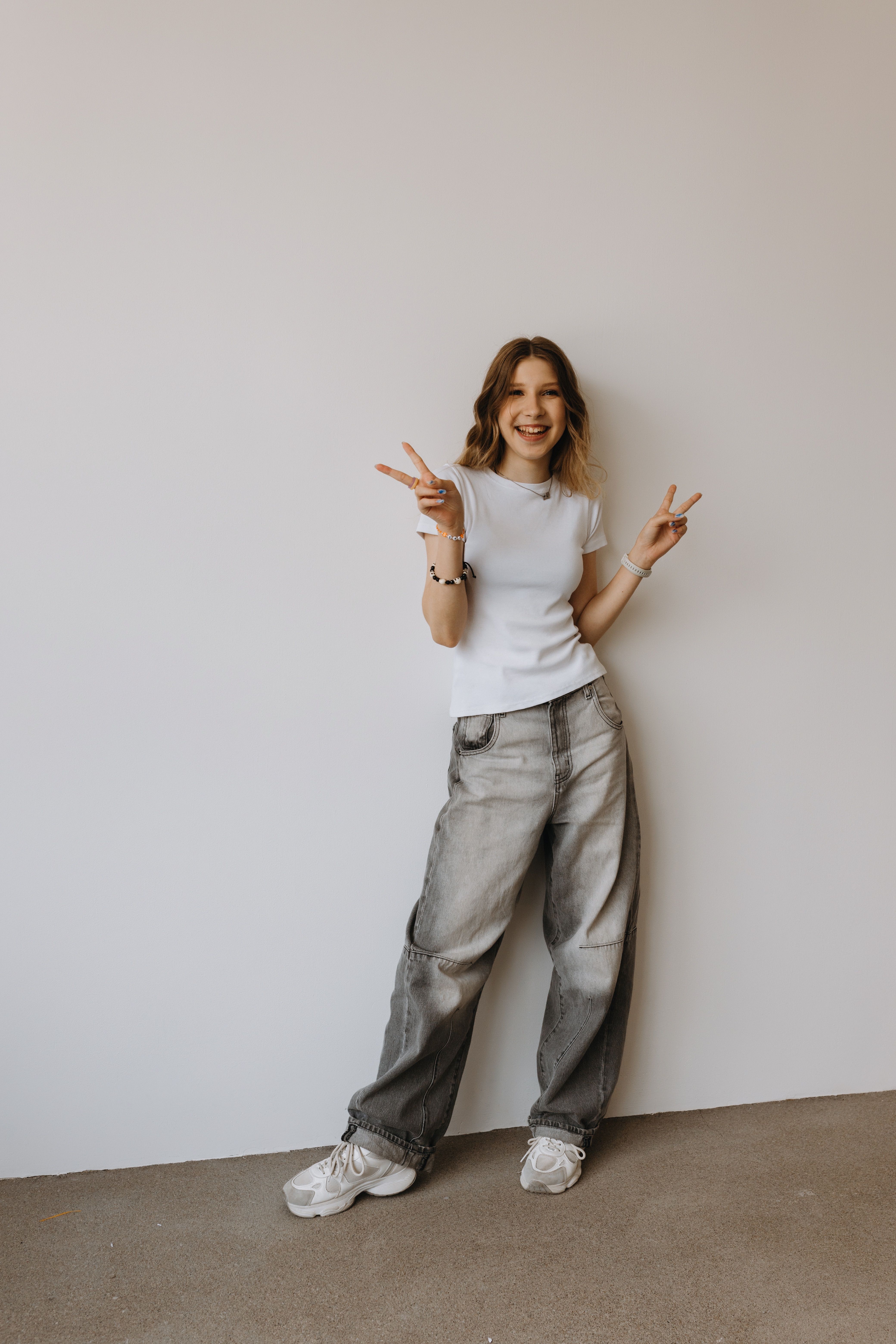 Casual Teen Posing Indoors with Peace Signs · Free Stock Photo