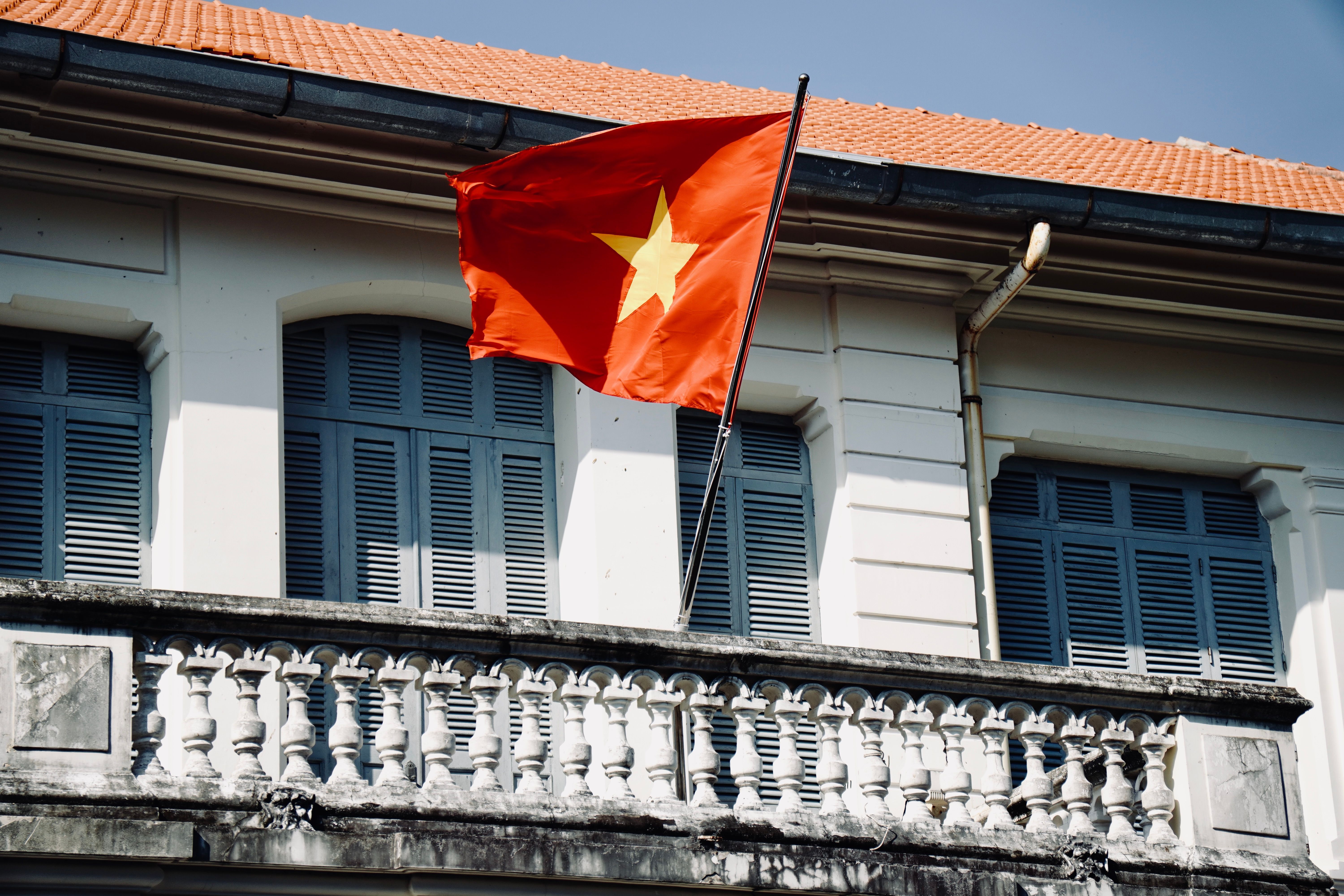 Vietnamese Flag on Colonial Building Balcony · Free Stock Photo