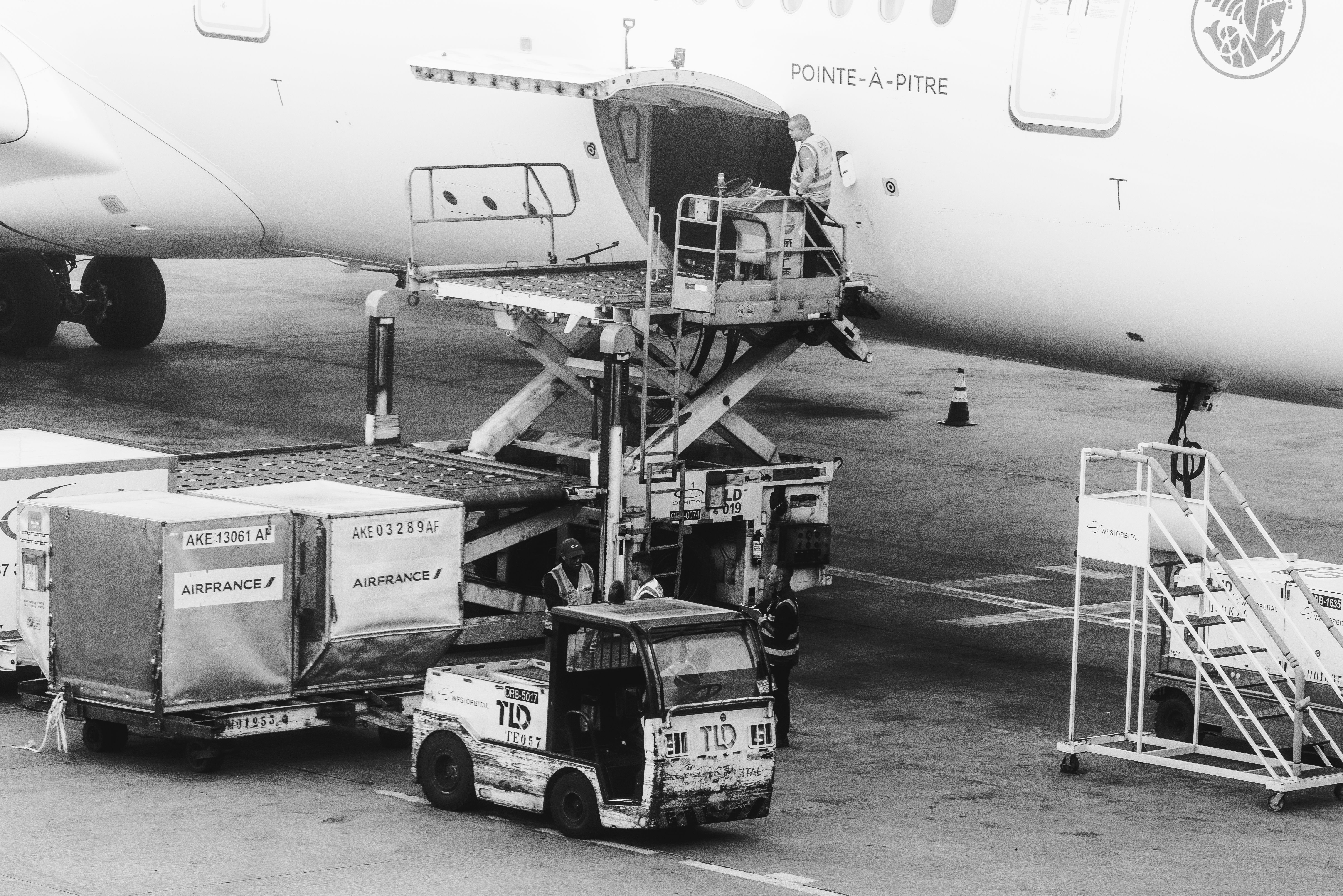 Aircraft Cargo Loading at Airport in Black and White · Free Stock Photo