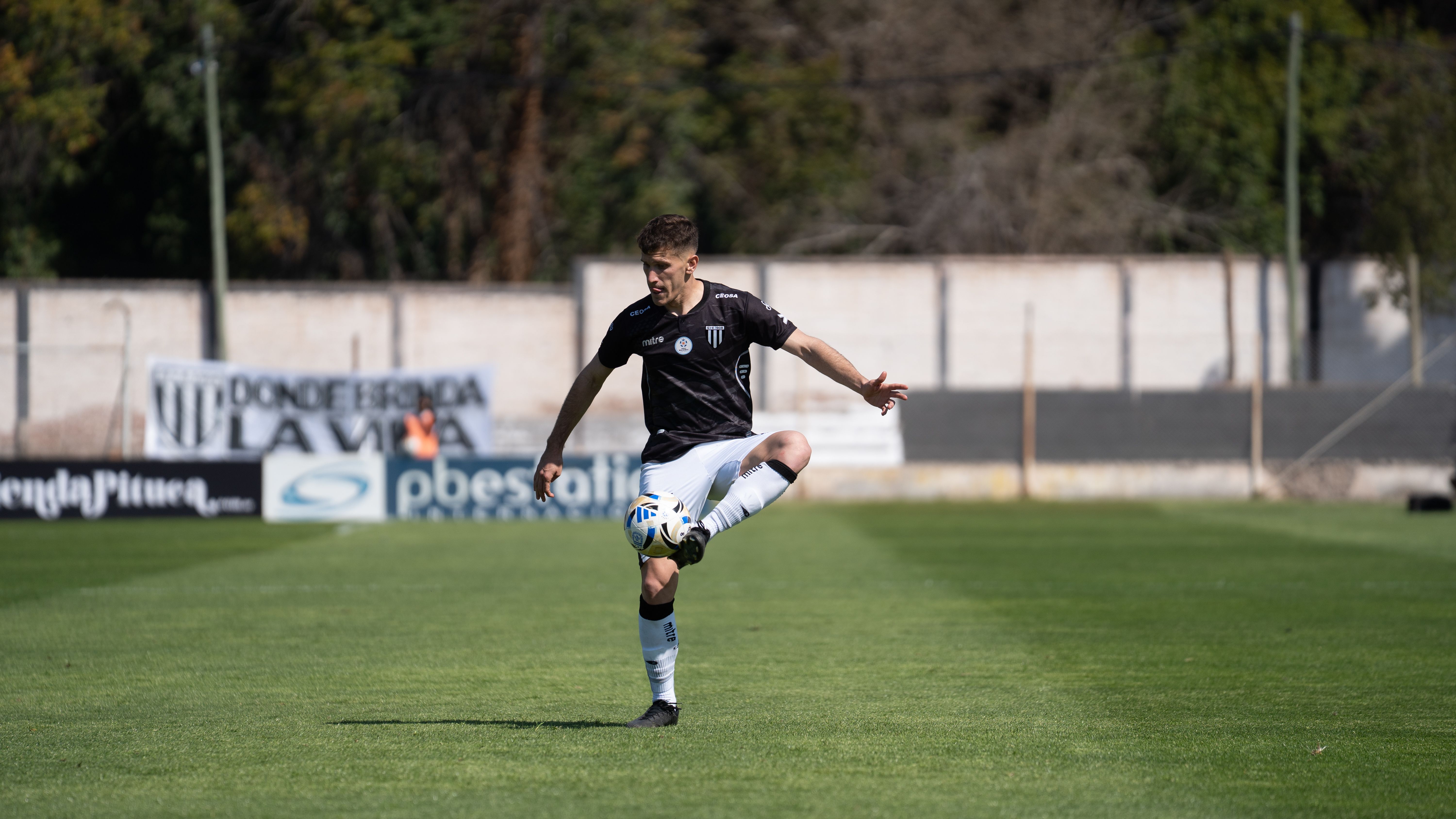 Soccer Player Balancing Ball in Game Action · Free Stock Photo