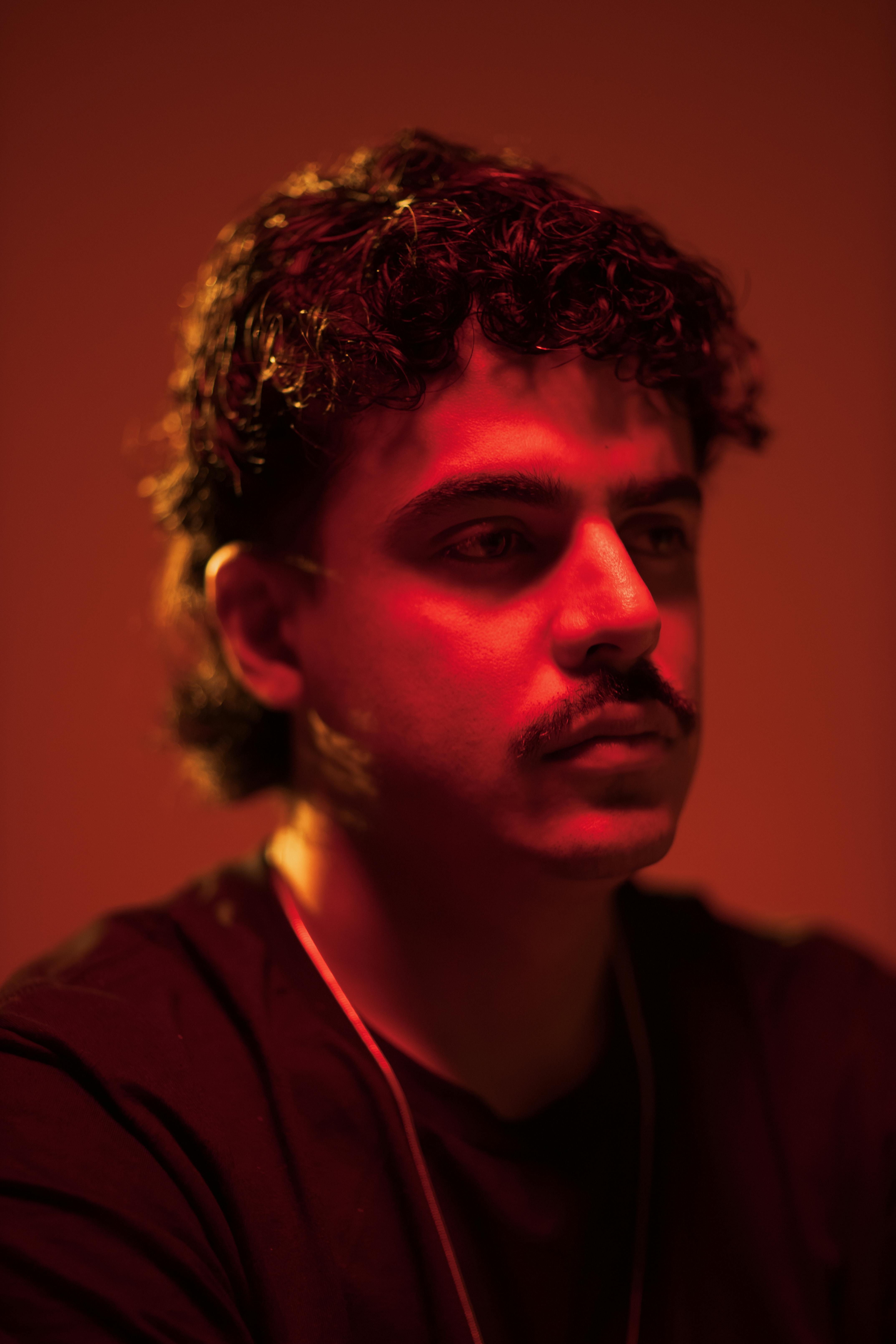 Free Male portrait with dramatic red lighting, expressing a thoughtful ...