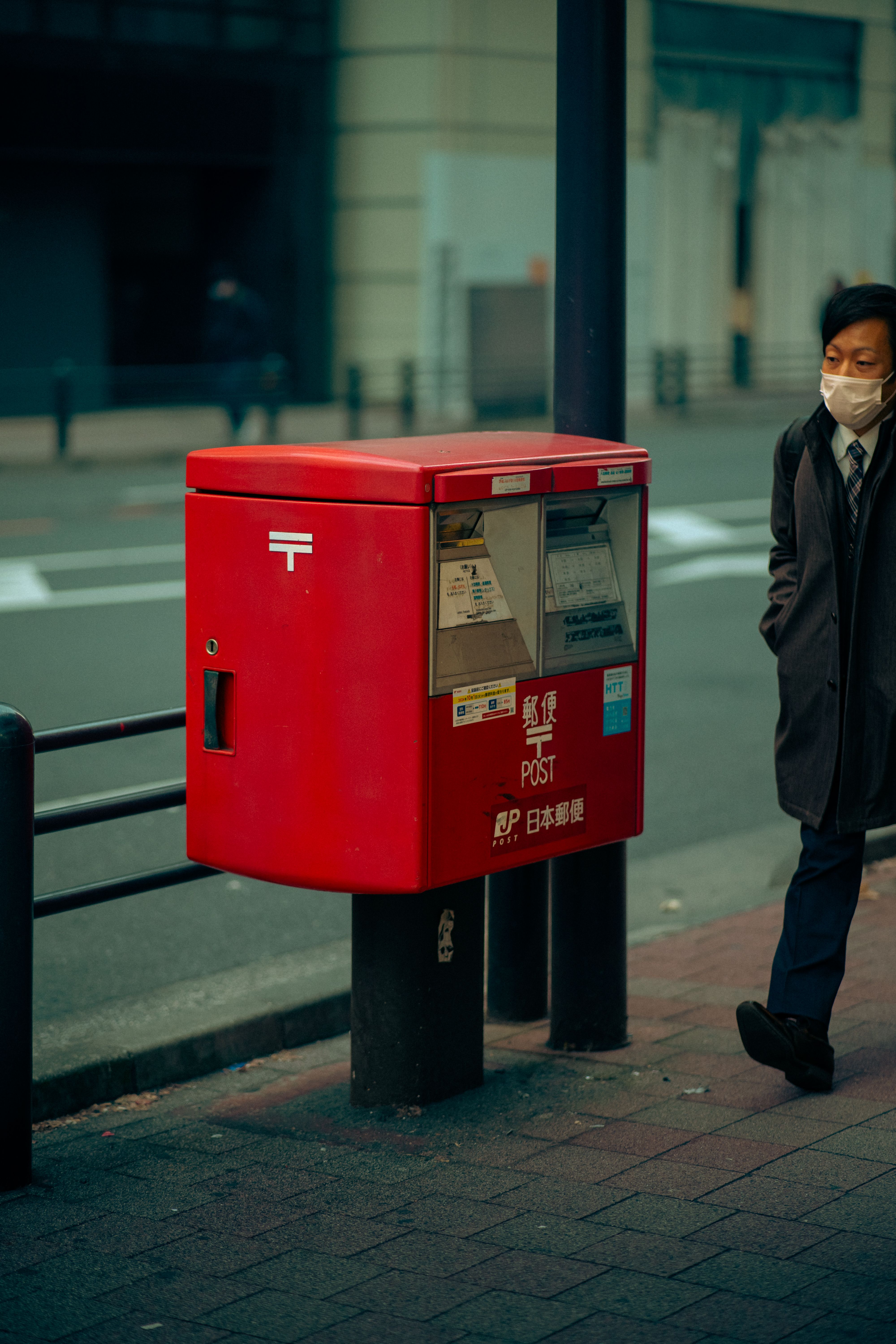 Man Walking by Red Japanese Postbox in Osaka · Free Stock Photo