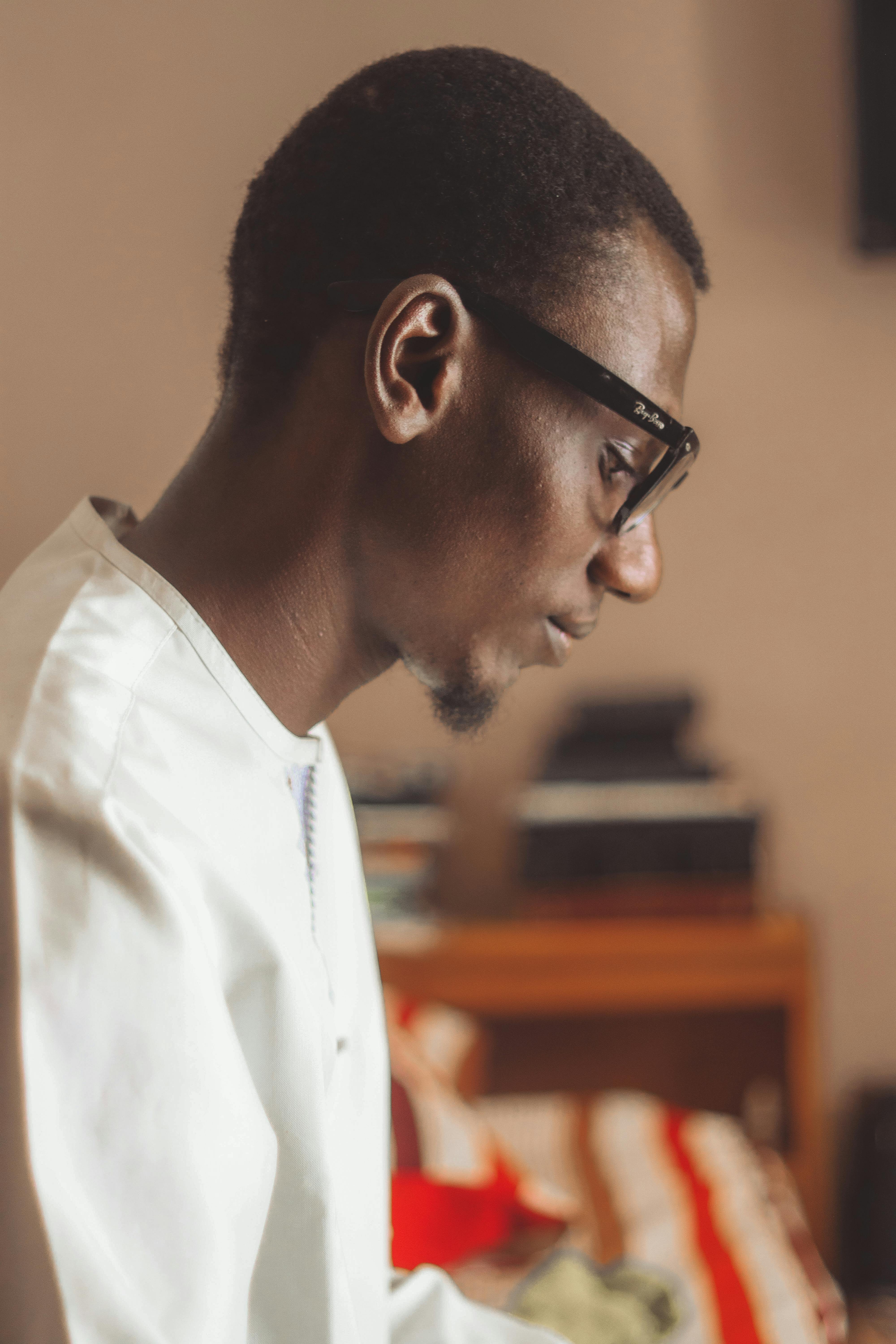 Thoughtful Man in Profile Indoors · Free Stock Photo