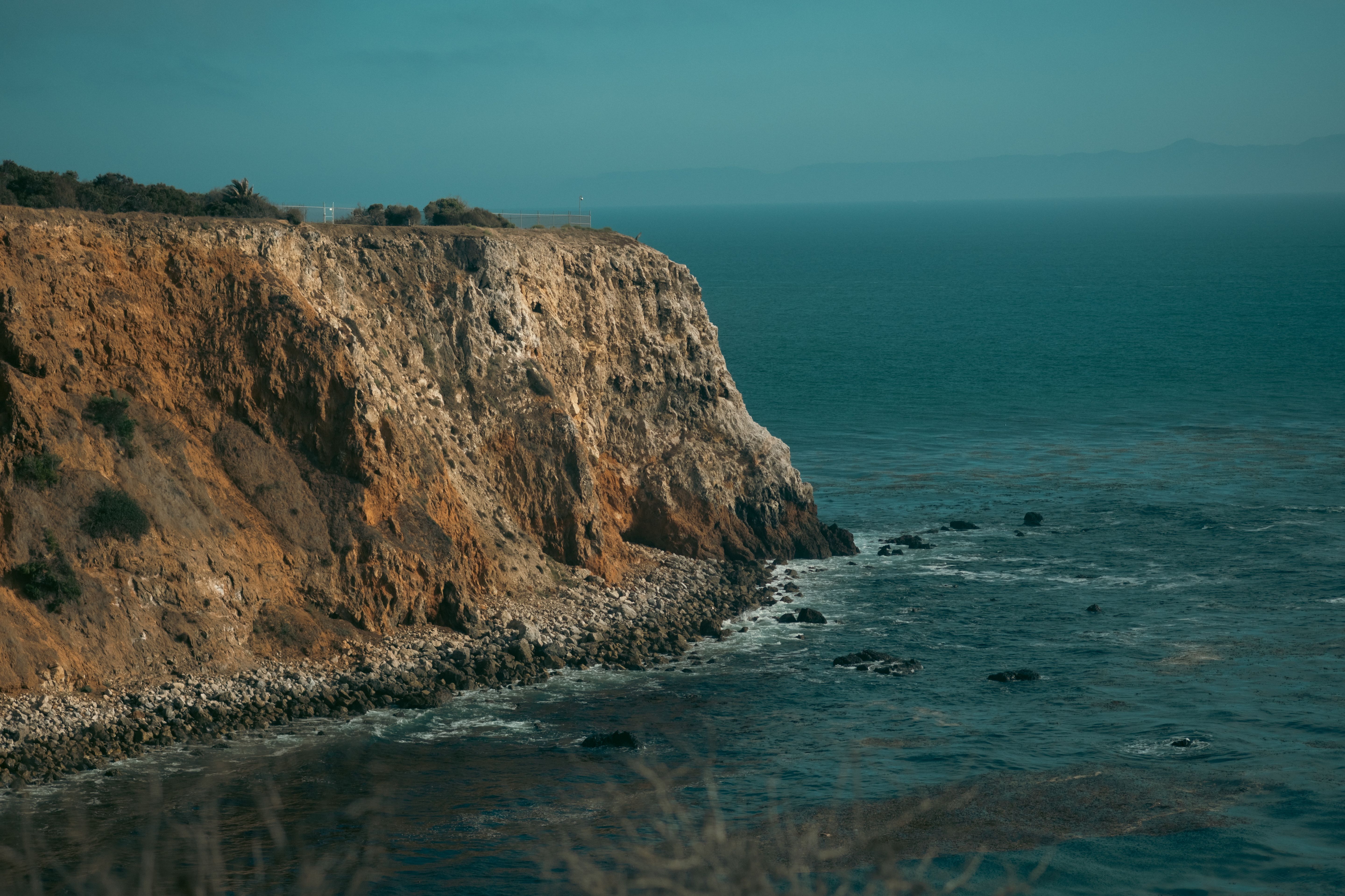 Dramatic Coastal Cliff Overlooking Ocean Waves · Free Stock Photo