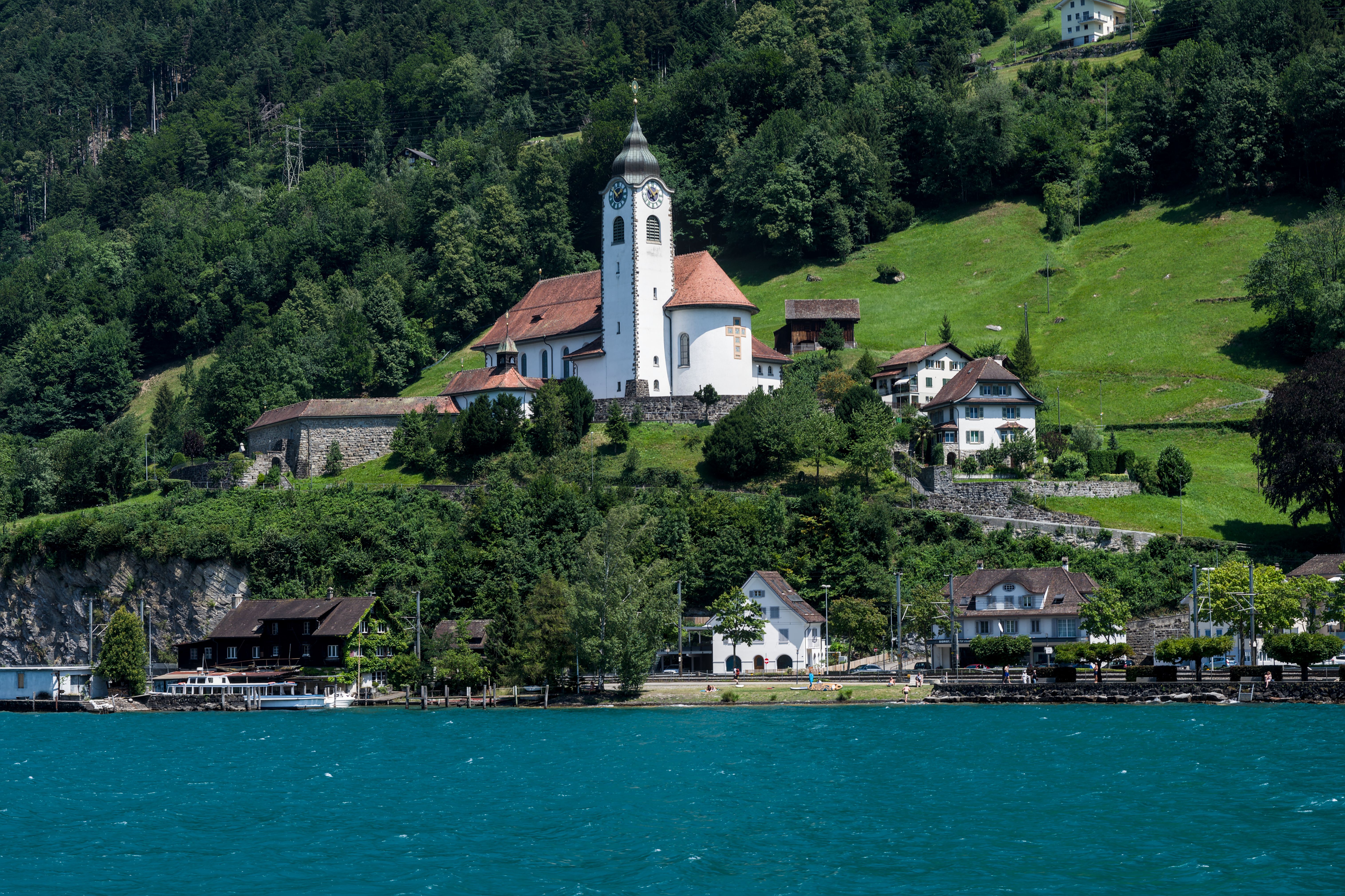 Scenic Swiss Village with Historic Church by Lake · Free Stock Photo