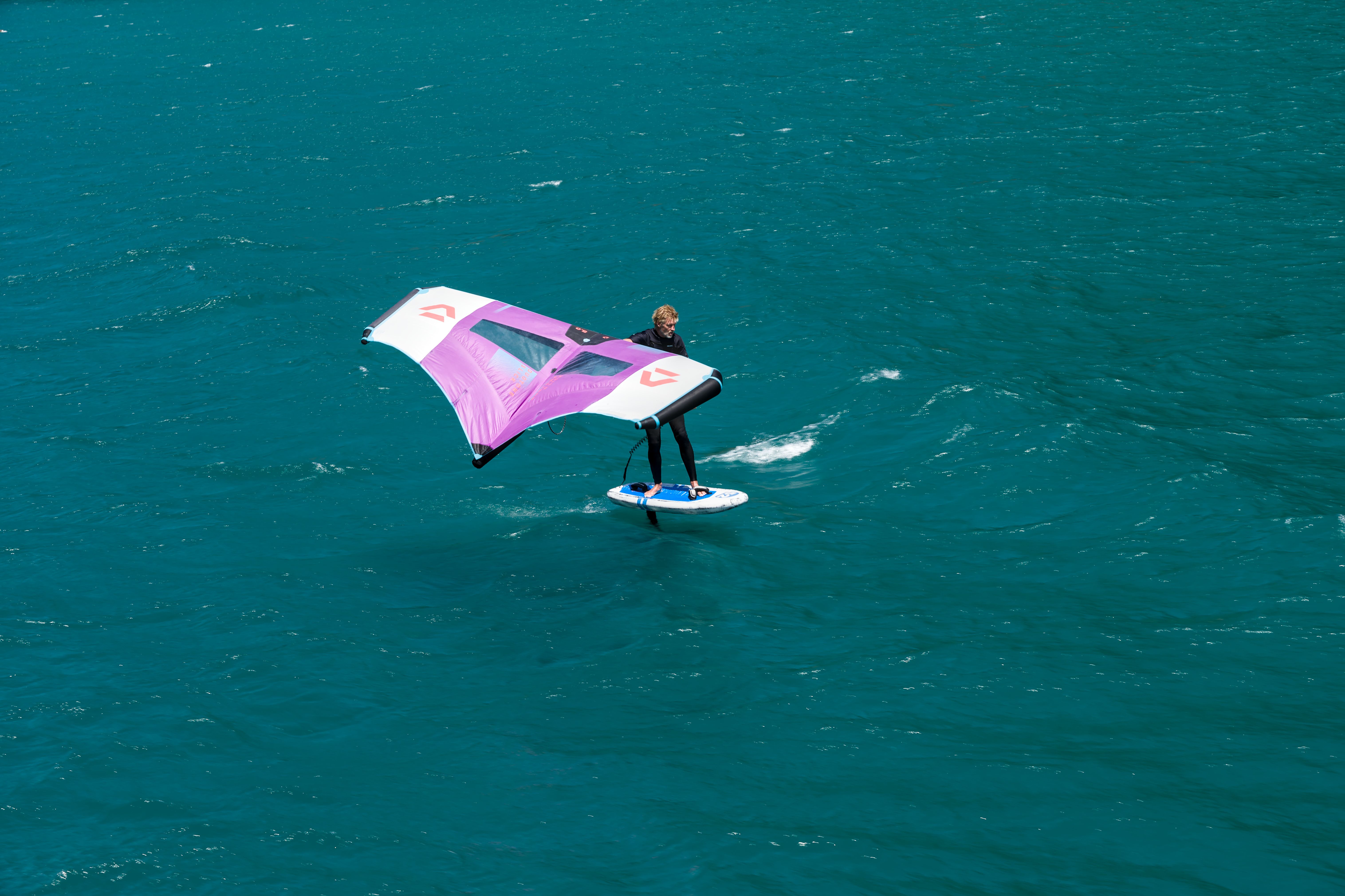Exciting Wing Foiling Adventure on Turquoise Lake · Free Stock Photo