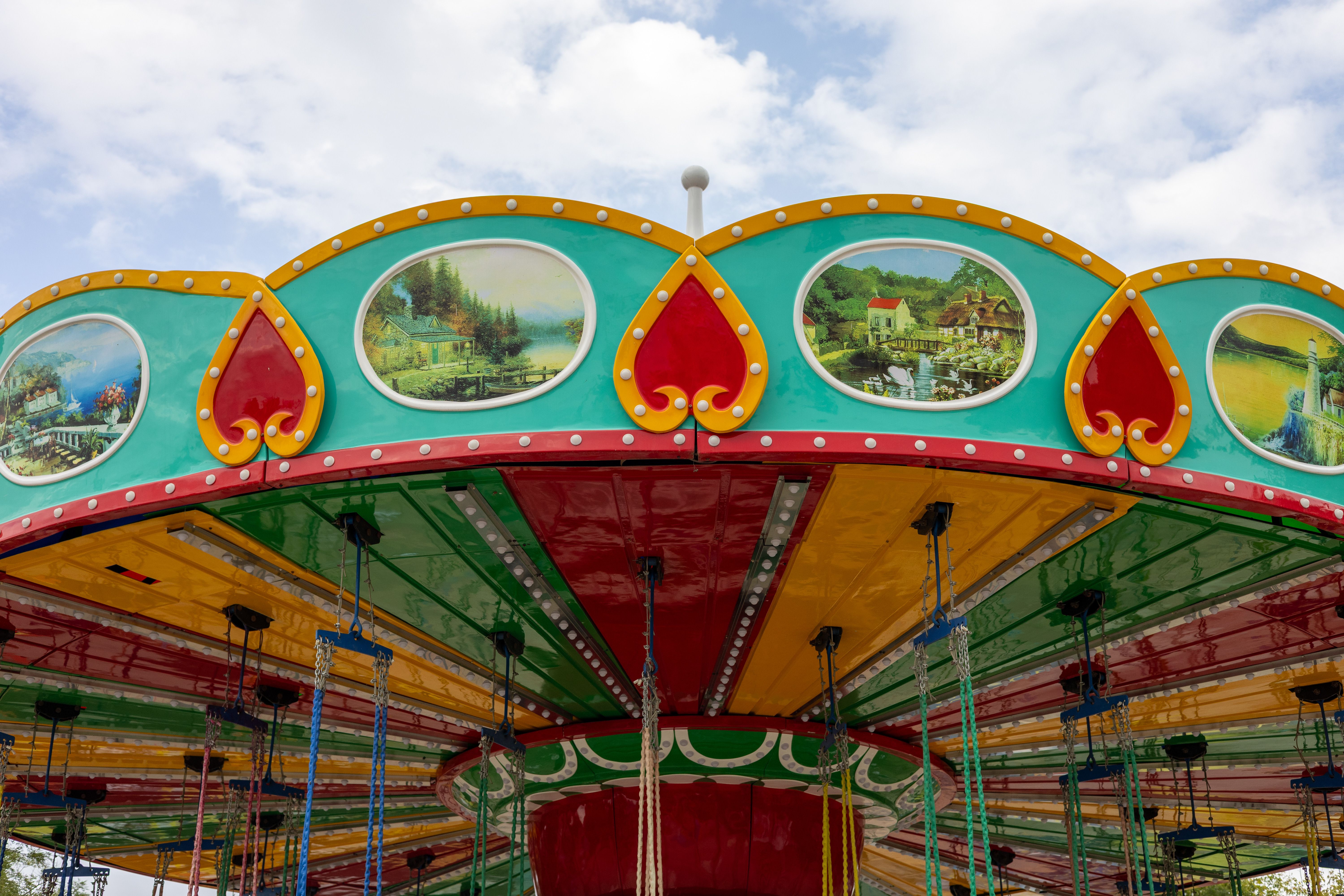Colorful carousel top with vibrant art · Free Stock Photo