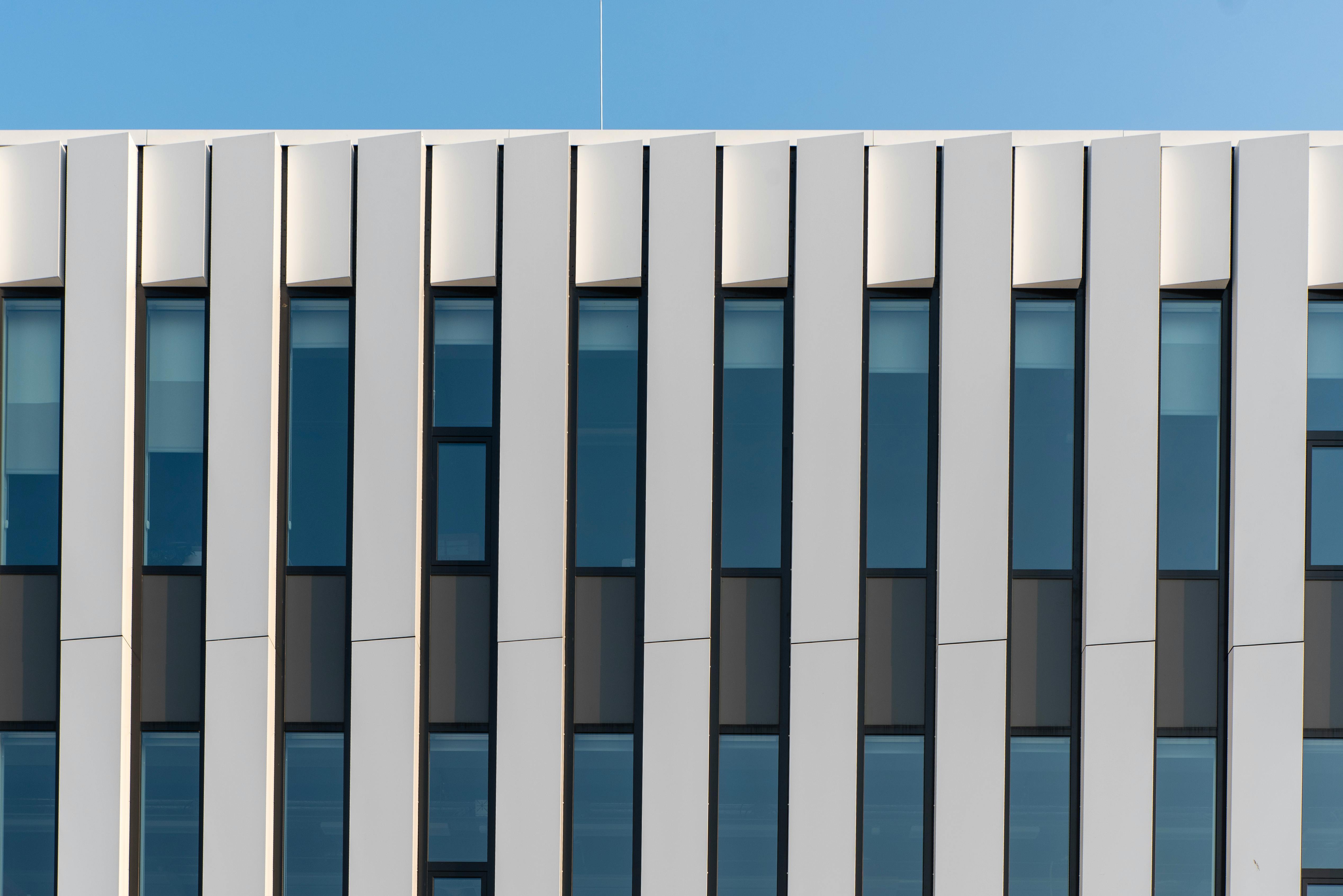 Modern Architectural Facade with Glass Windows · Free Stock Photo